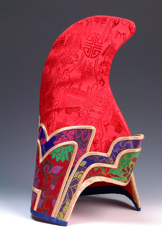 FOUR TIBETAN HATS, including black velvet monk’s hat and Kagyu hat. The ...