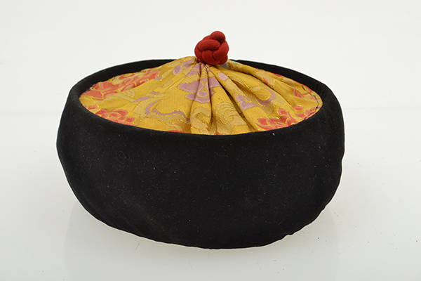 FOUR TIBETAN HATS, including black velvet monk’s hat and Kagyu hat. The ...