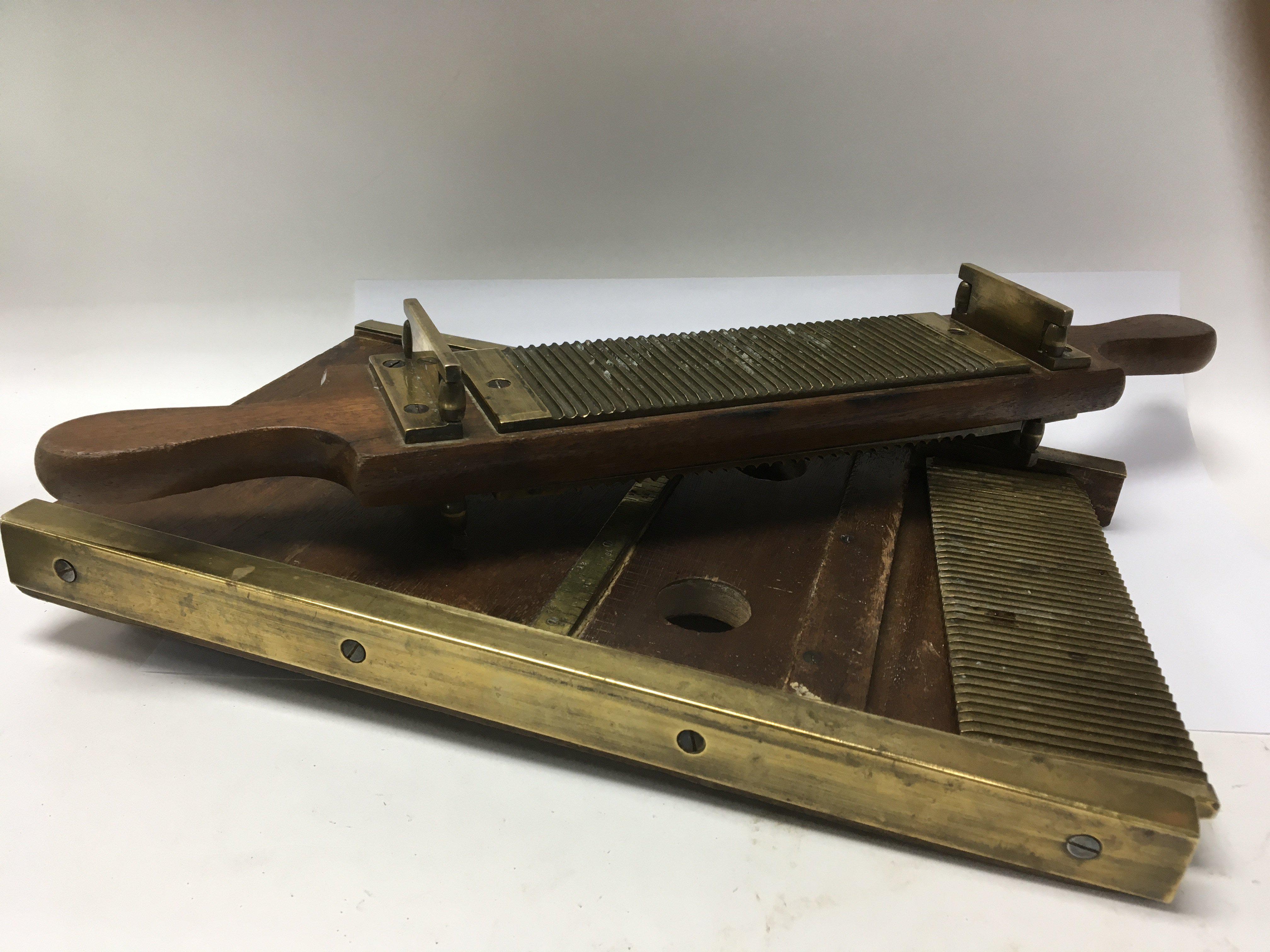 A Victorian mahogany pill maker with brass supports