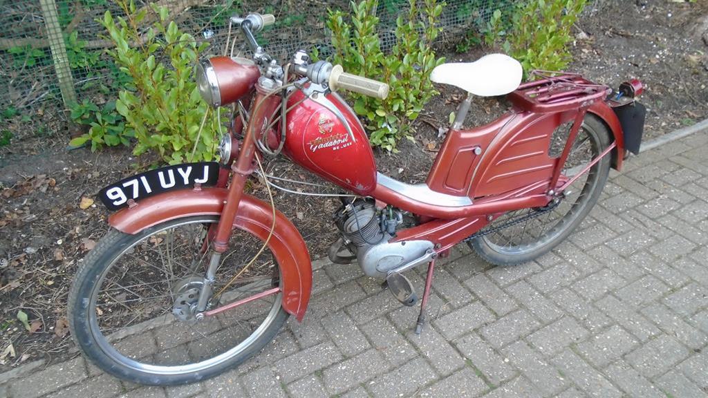 A 1957 Phillips Gadabout moped, registration number 971 UYJ, red ...
