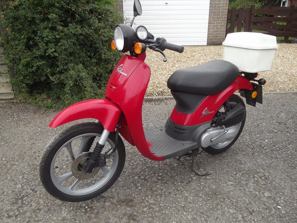 A 1999 Honda Sky SGX50 scooter, registration number T874 PDG, red. With ...