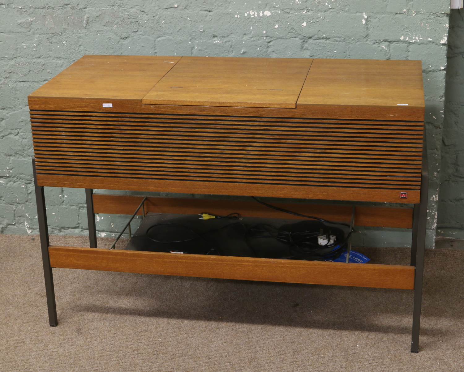 A 1970s teak retro stereo radiogram with 4 speed Garrard turn table.