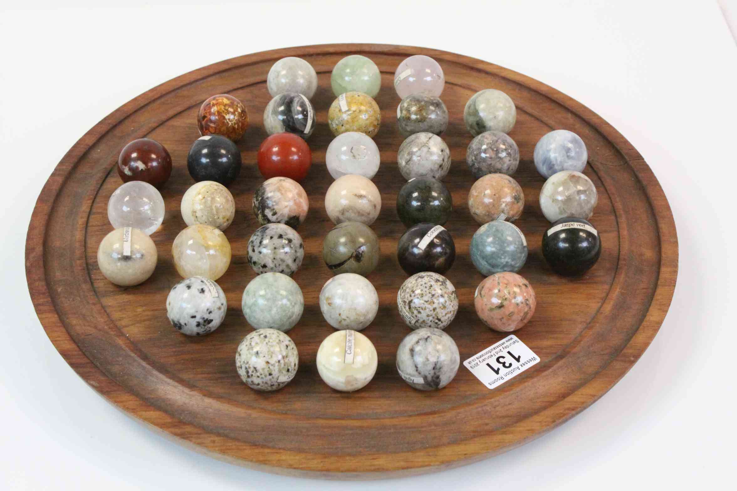 Solitaire game board with 37 gemstone balls