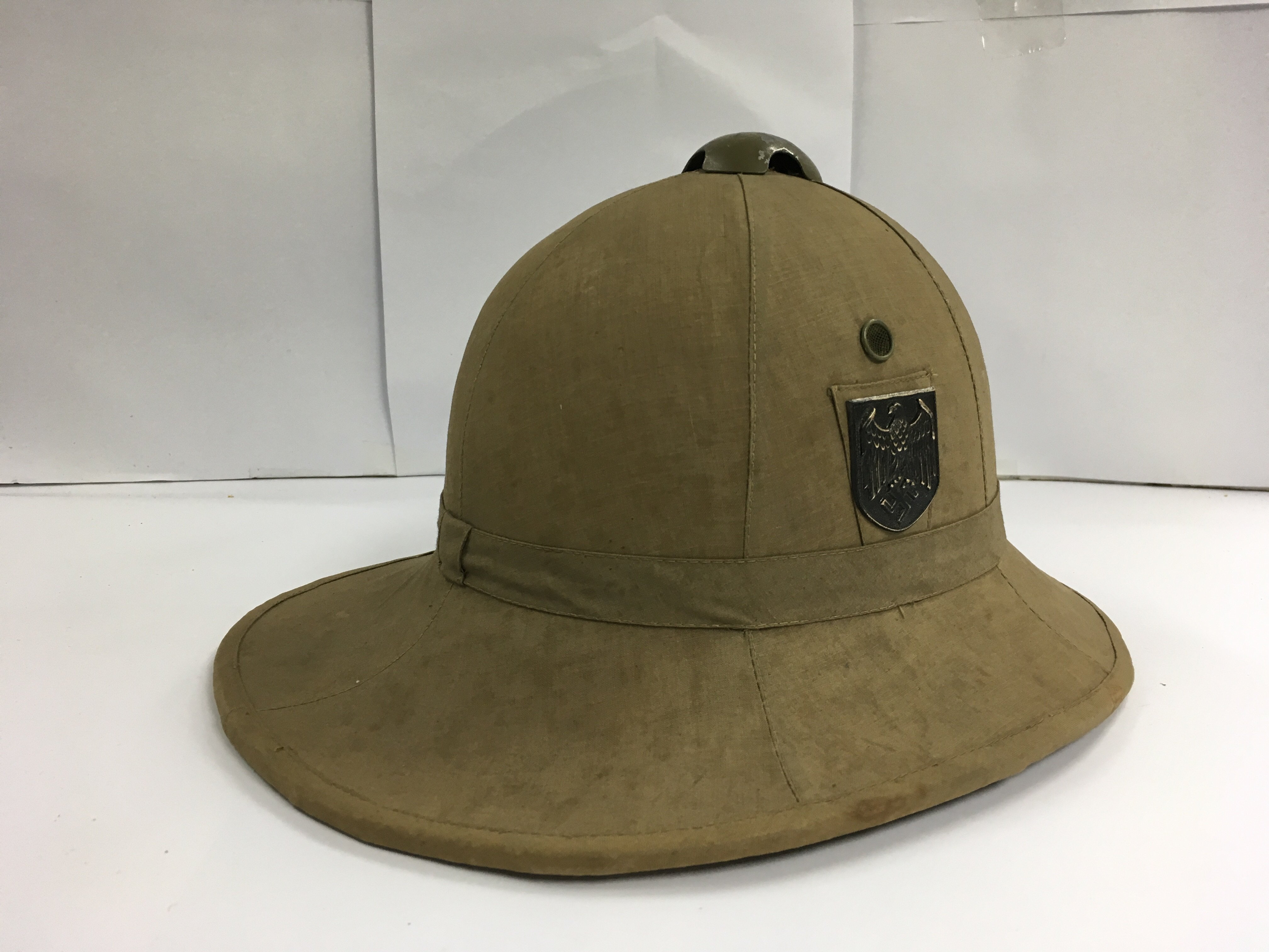 A German WW2 Pith helmet with affixed Reichsadler