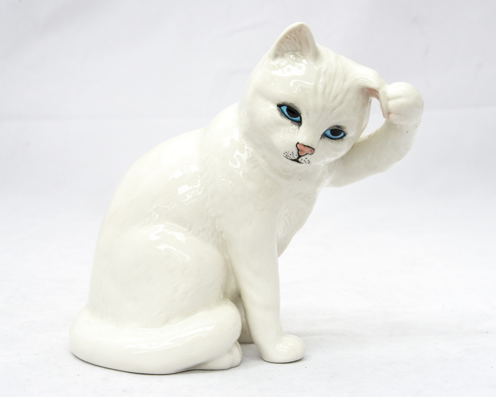 A Beswick cat, model No 1877, cat seated scratching ear, white gloss ...