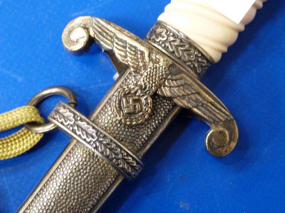 A reproduction German World War 2 Dagger featuring a Nazi Sigil with ...