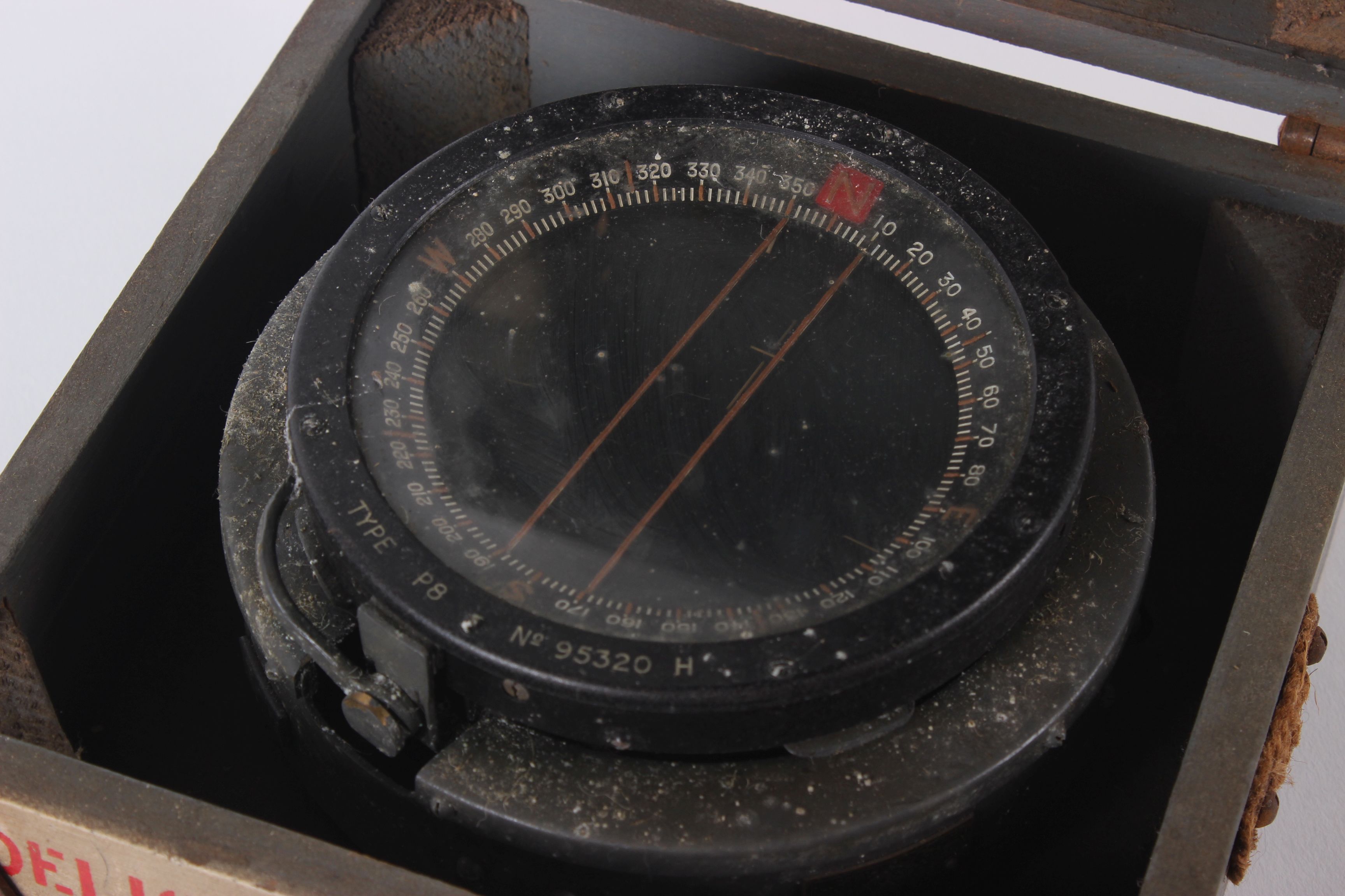 A World War II aviation compass, within painted box, believed to be ...