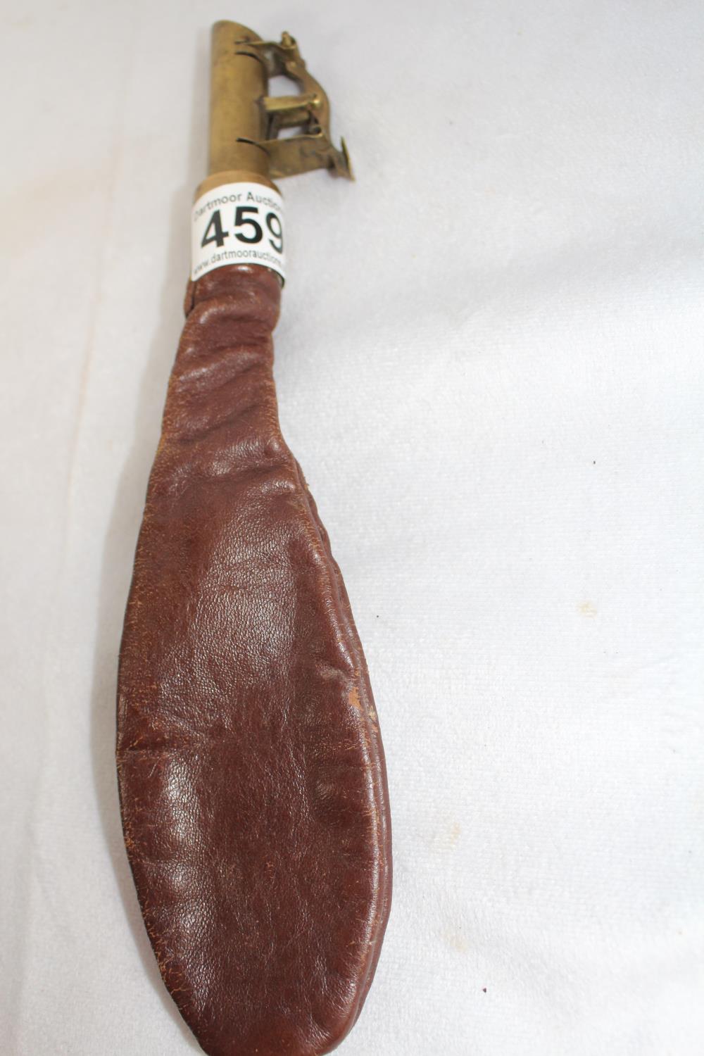 An antique leather pouch gun powder flask