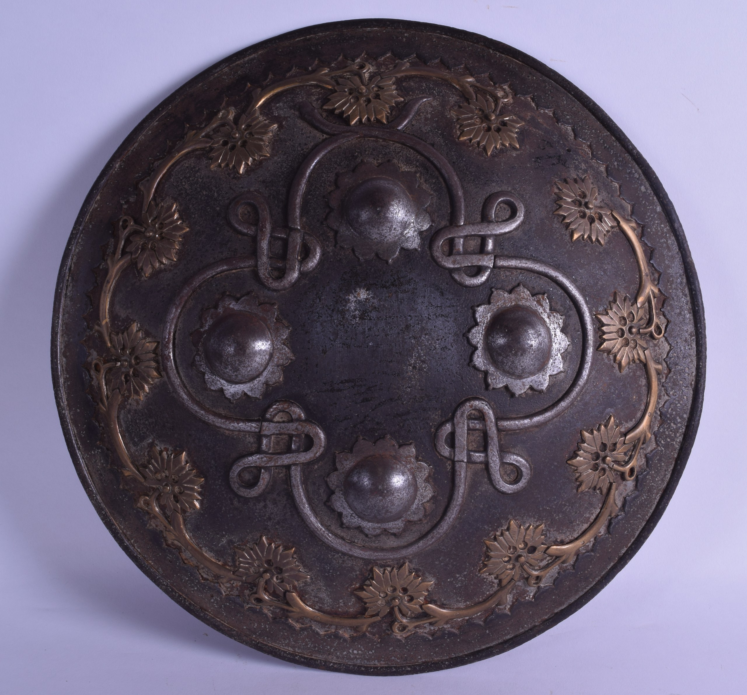 A TURKISH OTTOMAN STEEL CIRCULAR SHIELD overlaid with bronze scrolling ...