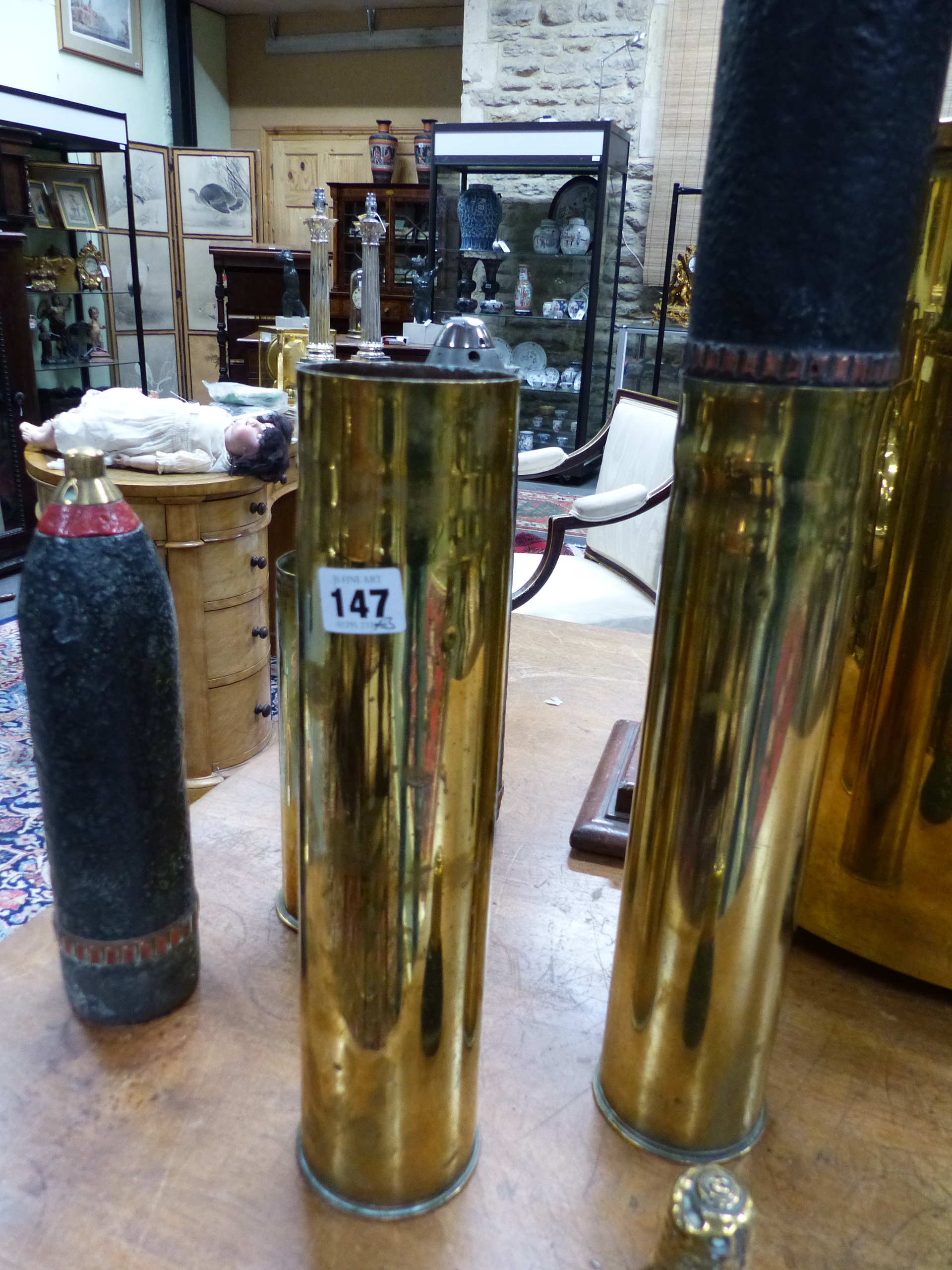 THREE VARIOUS HEAVY ARTILLERY SHELLS WITH PROJECTILES.