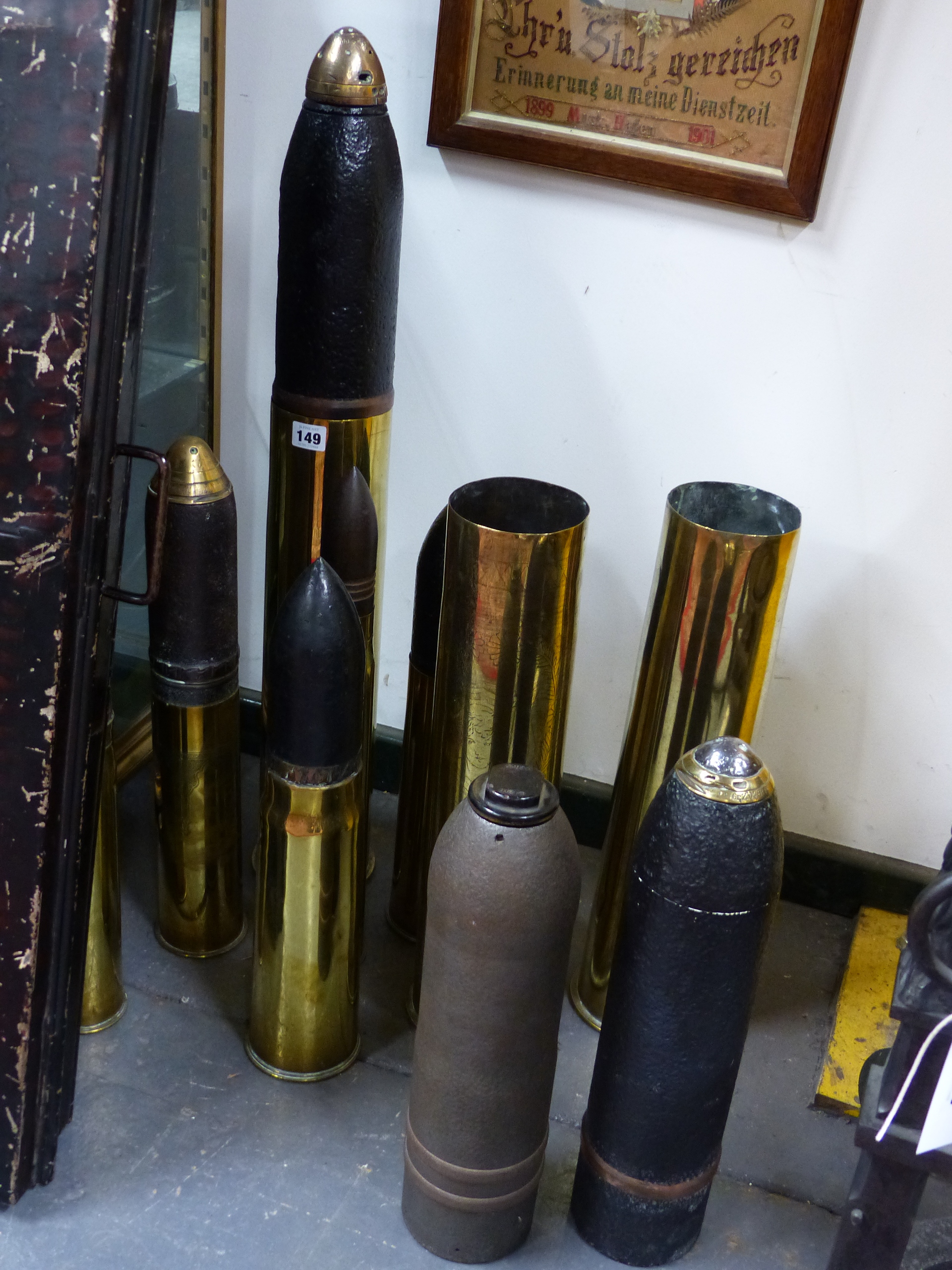 THREE LARGE HEAVY ARTILLERY SHELLS, ONE CASING WITH ENGRAVED TRENCH ART ...