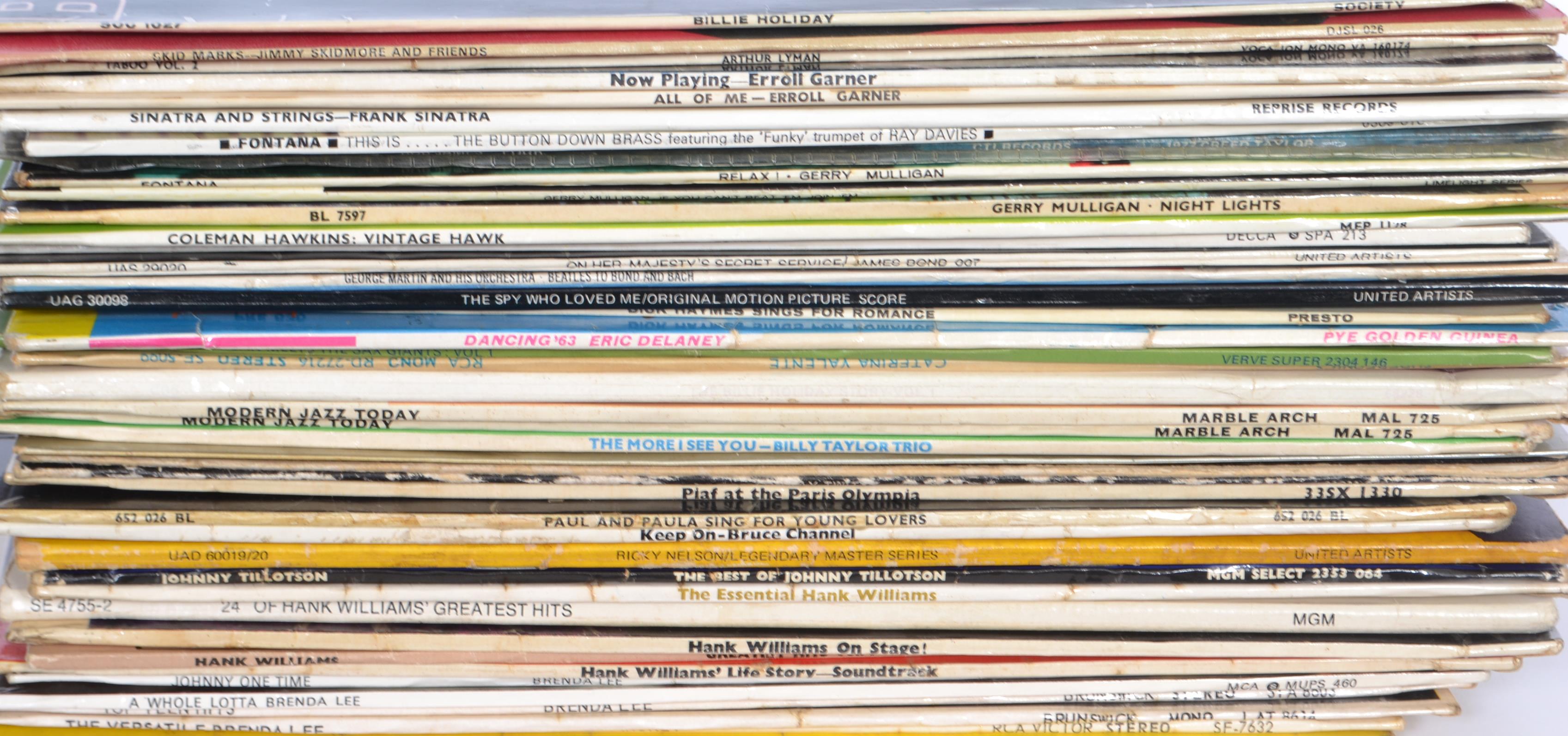 A collection of long play LP vinyl record albums featuring many ...