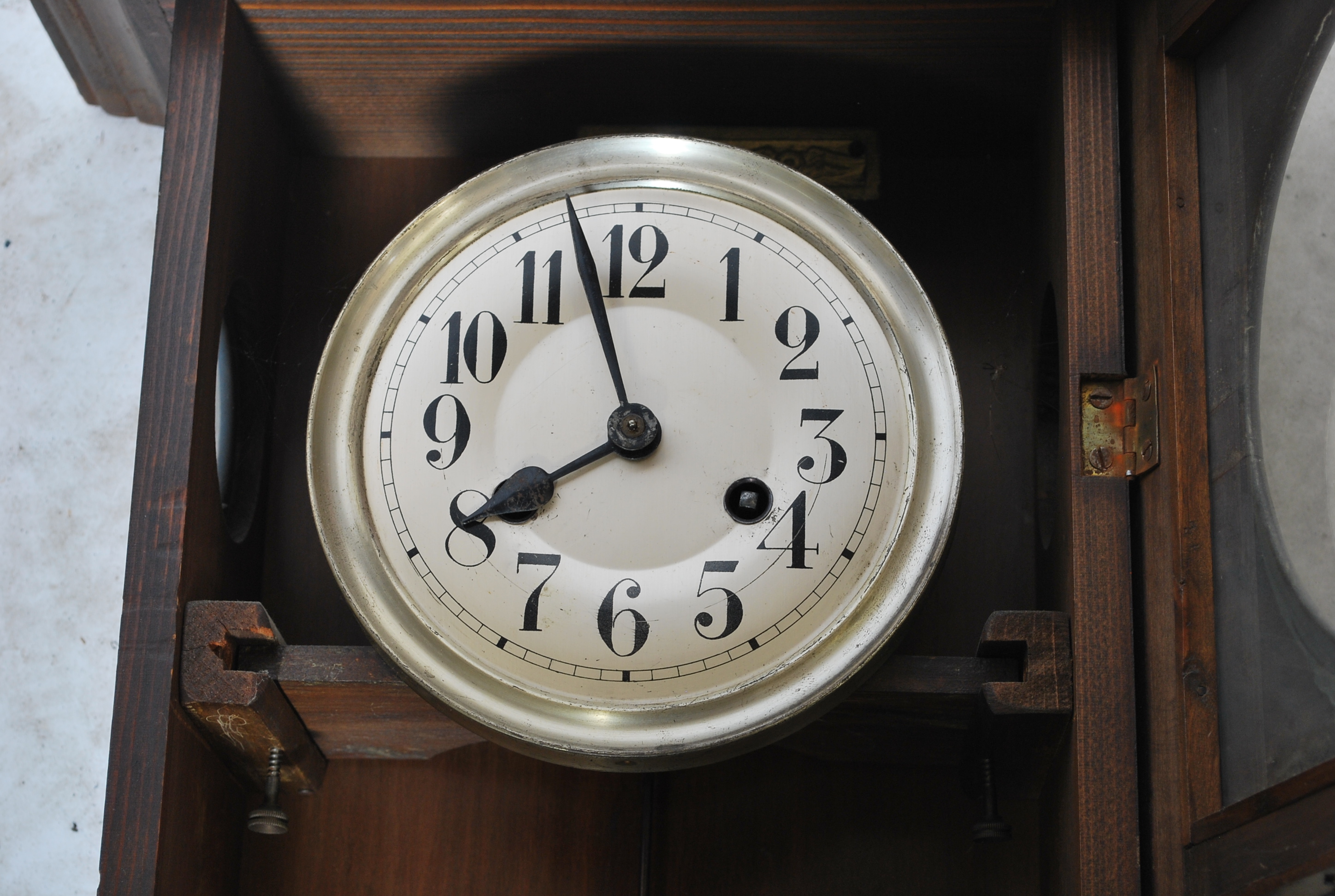 A 1920's oak wall clock having silvered dial with faceted hands over ...
