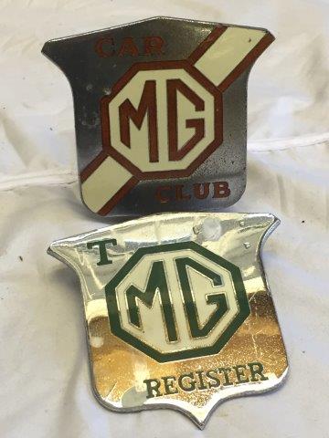 An MG Car Club badge and an MG T-Register car badge.