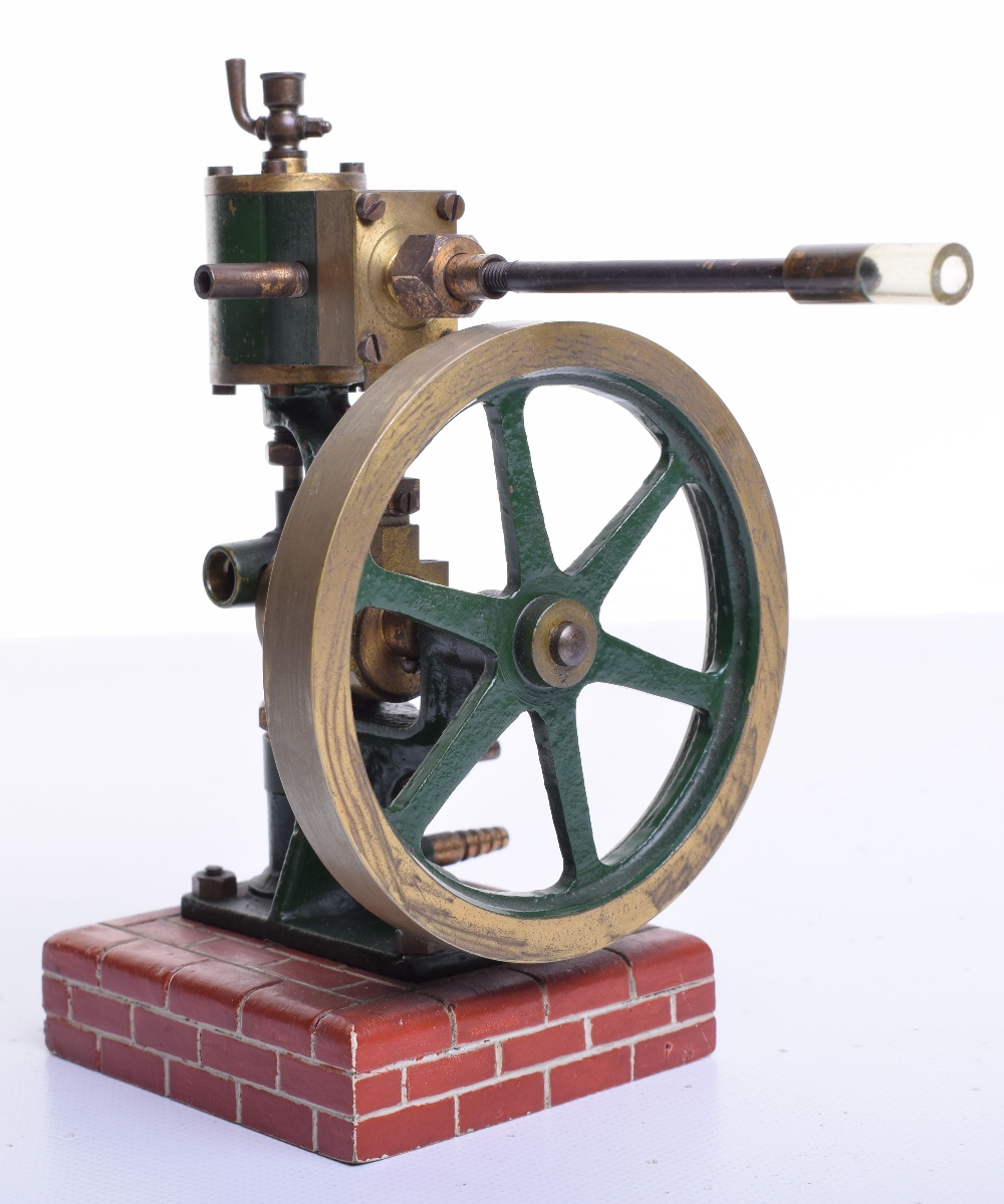 A model single cylinder vertical steam engine, with top mounted ...