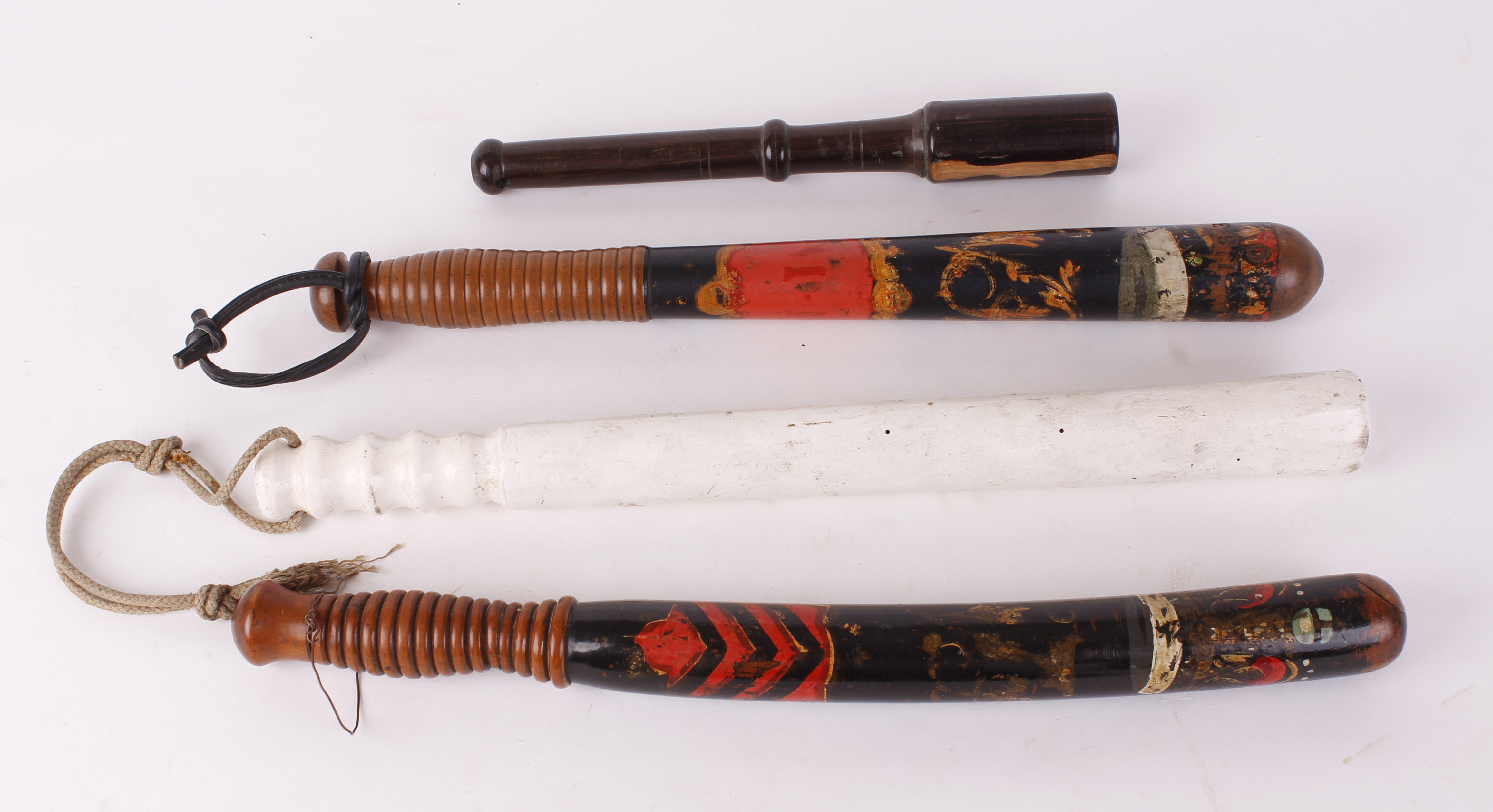 Two police style wooden truncheons together with two black painted ...