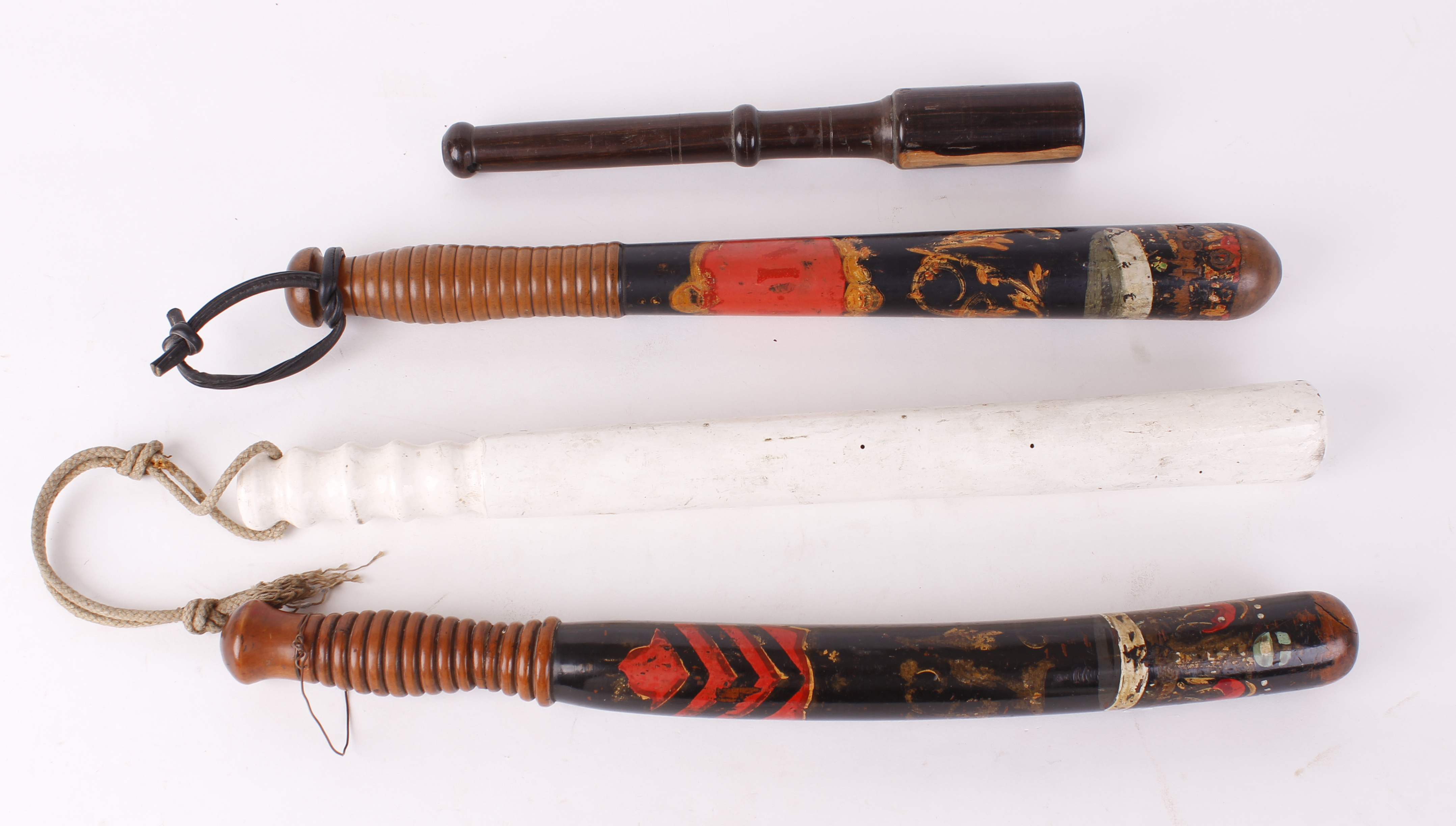 Two police style wooden truncheons together with two black painted ...