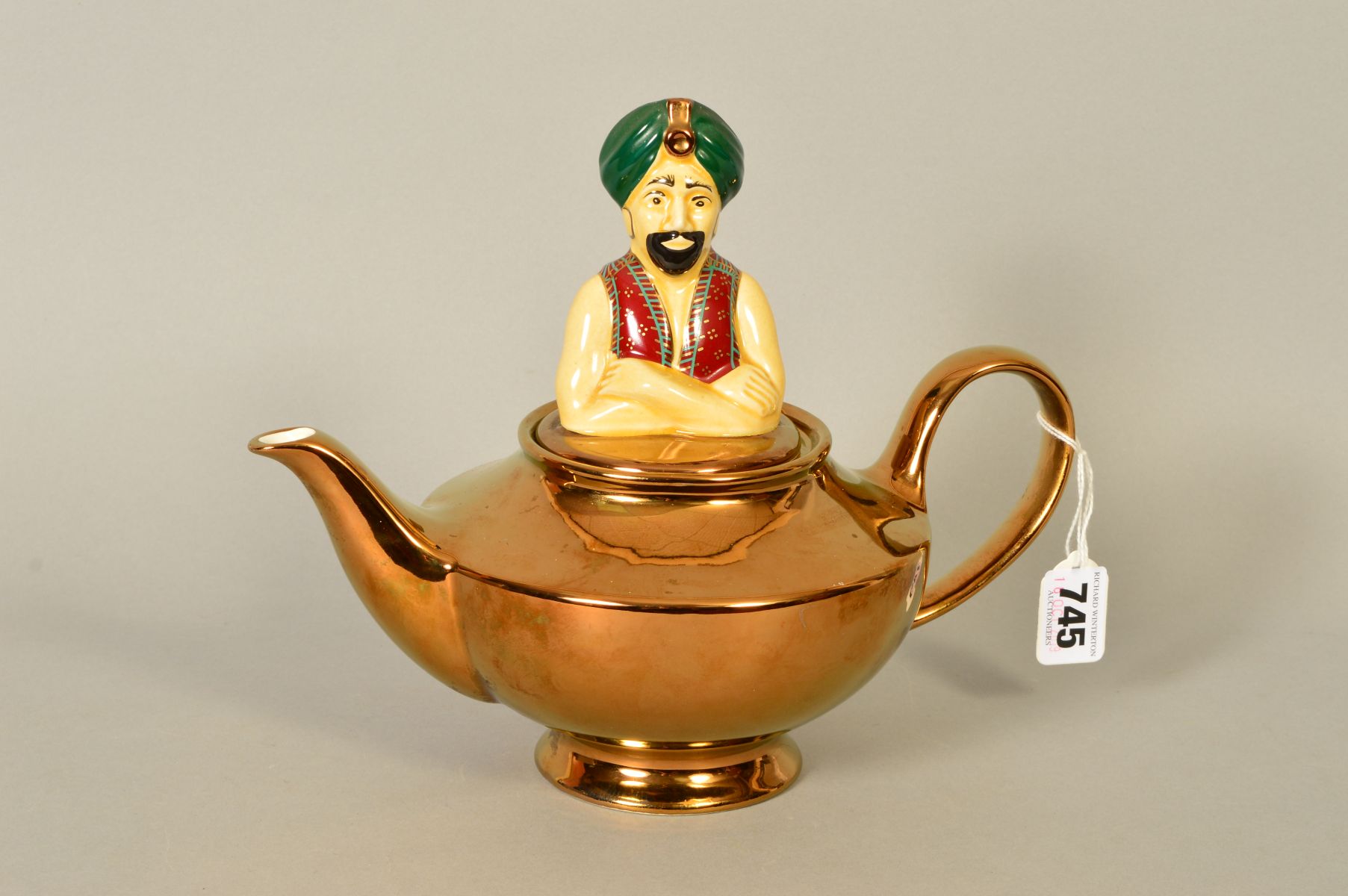 A WADE NOVELTY 'THE GENIE TEAPOT', modelled as the genie's head as the ...