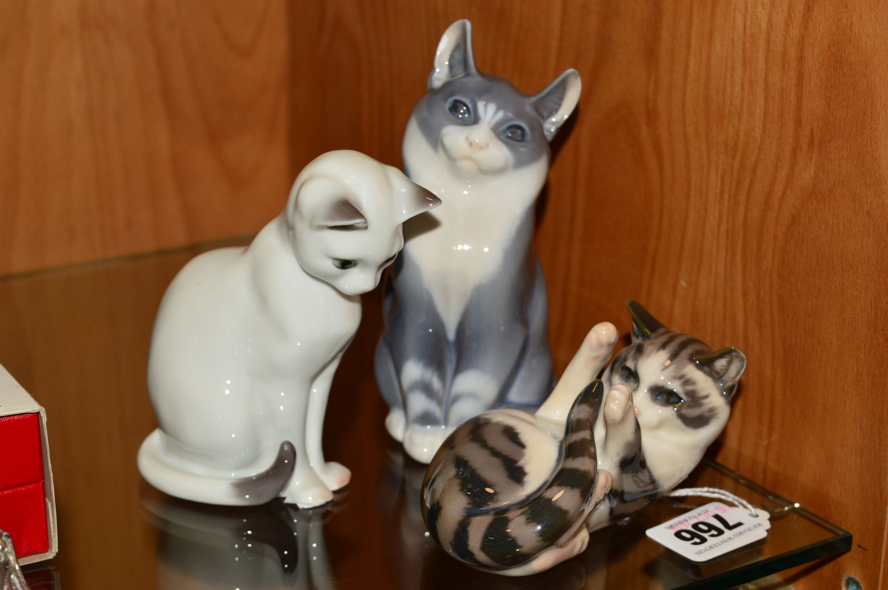 THREE ROYAL COPENHAGEN CATS, Playful Cat No 727, a seated white cat No ...