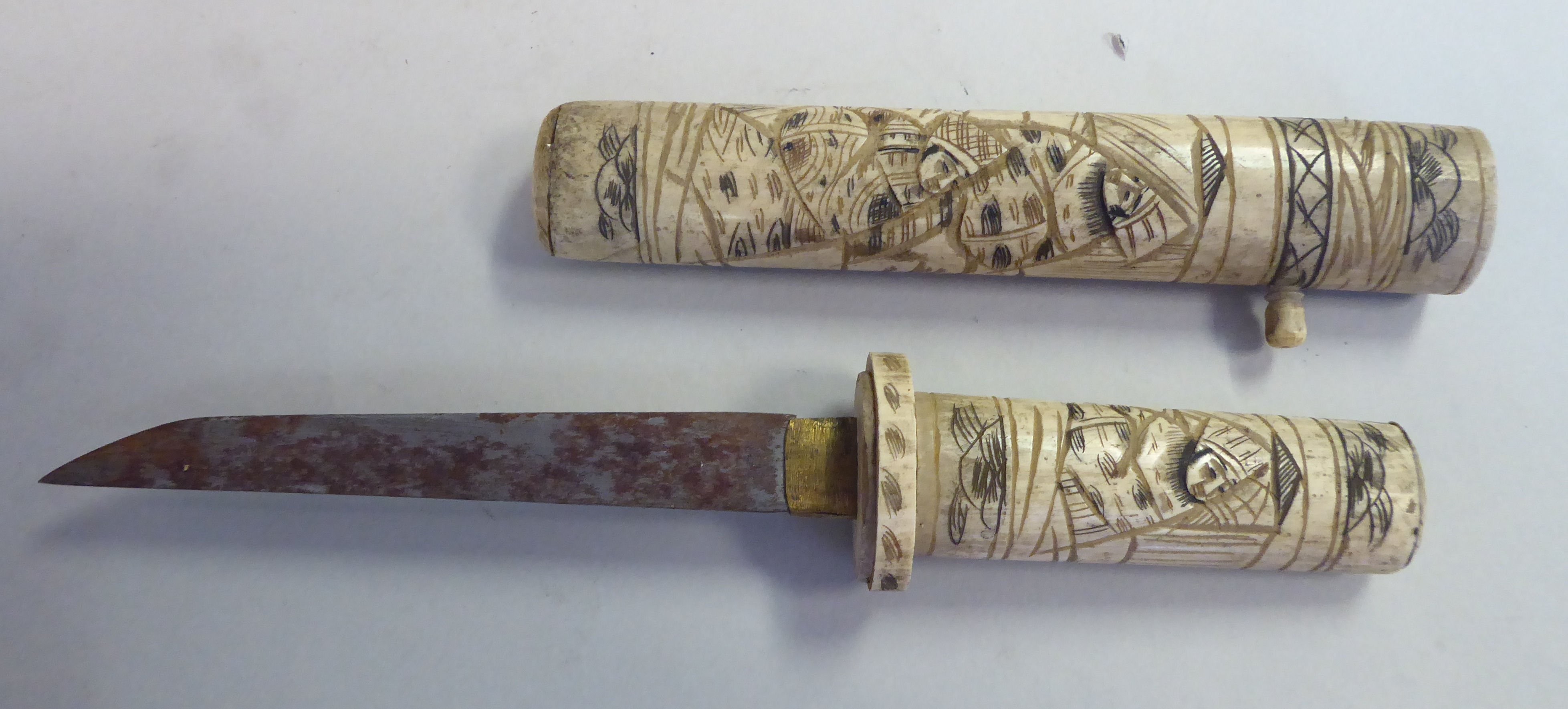 An early 20thC Japanese dagger with a carved bone handle the blade 5.25 ...