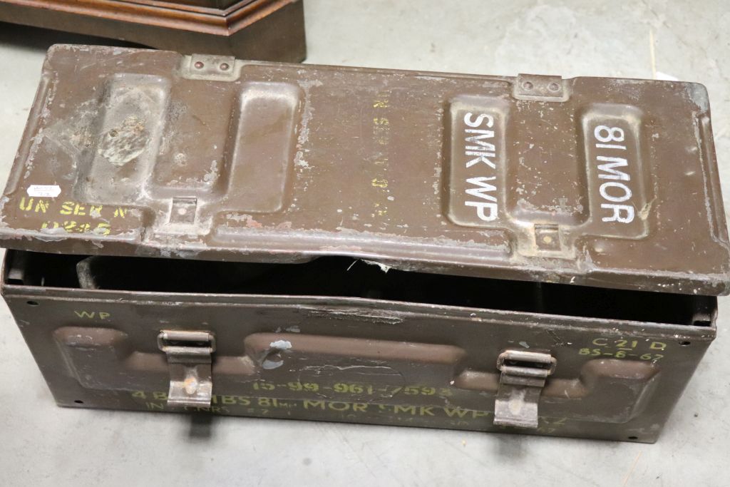 A metal military mortar shell box with various tools