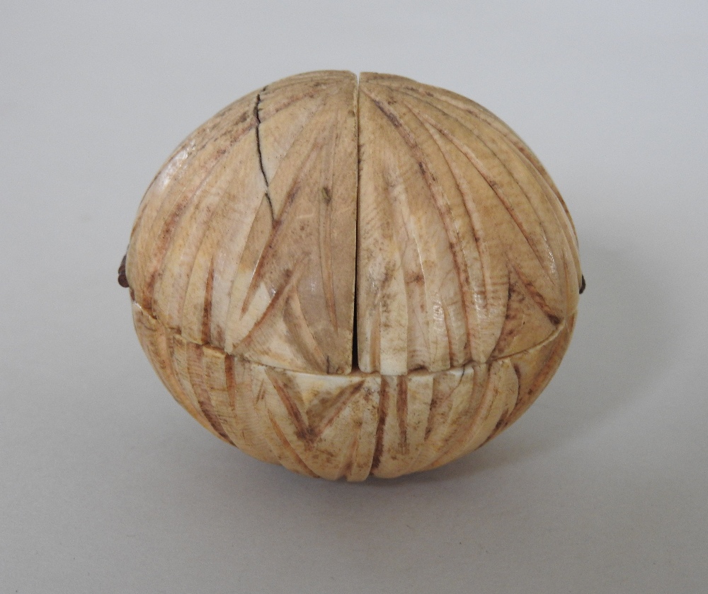 A 19th century Dieppe carved bone triptych of spherical form, 4 ...