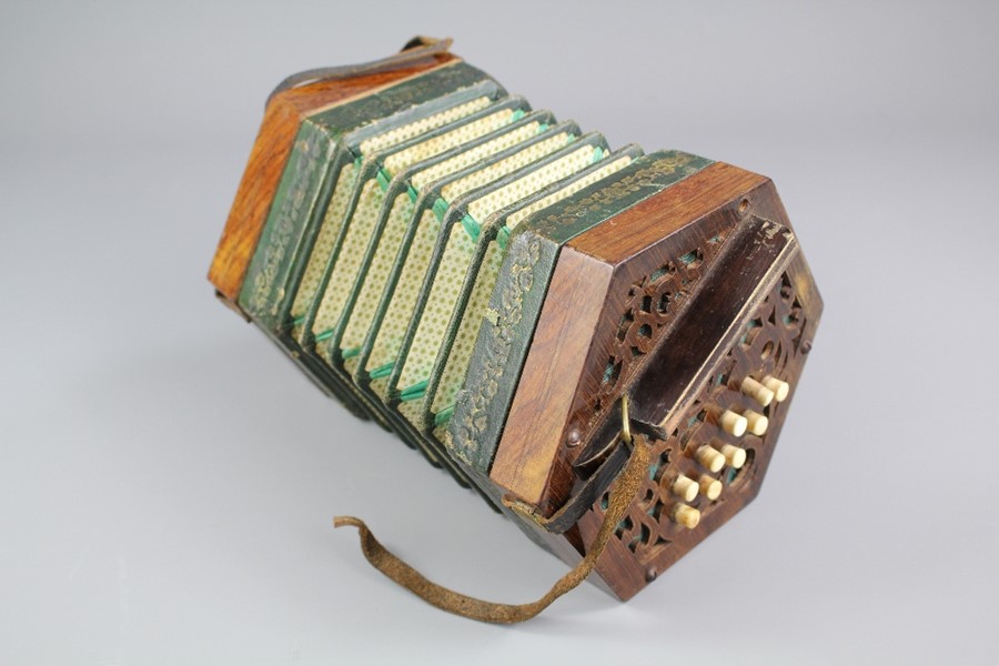 An Antique German Rosewood Concertina; the concertina in the original box.