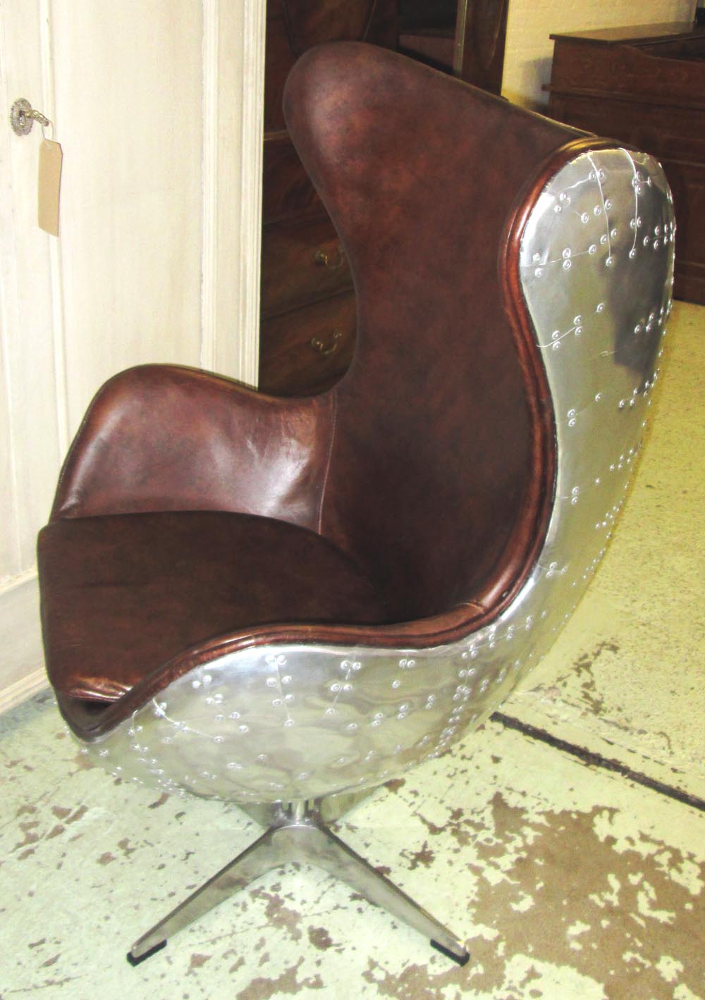 EGG CHAIR, aviator style, brown leather and riveted aluminium with ...