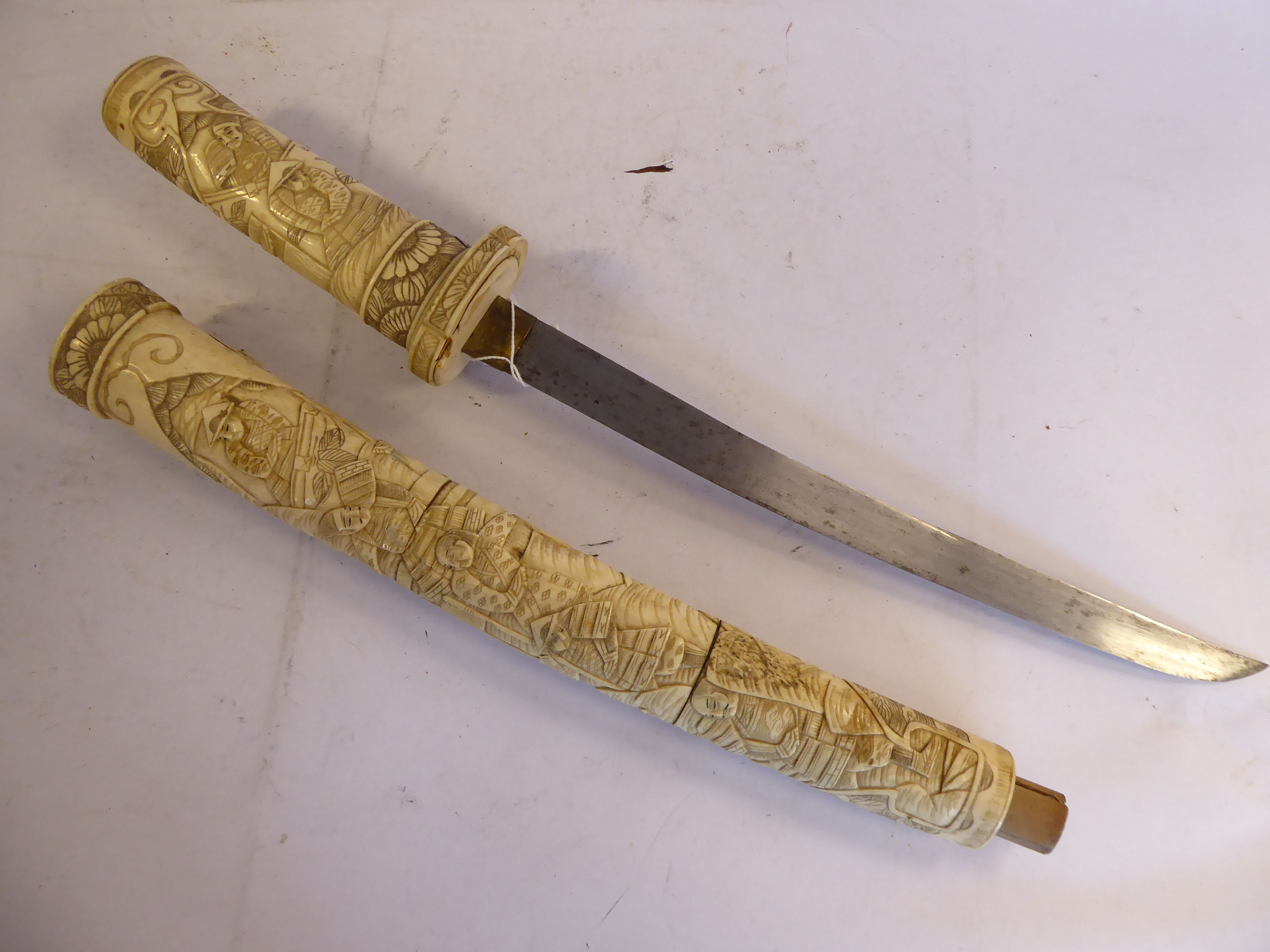 A late 19th/early 20thC Japanese short sword, the curved blade 11''L ...