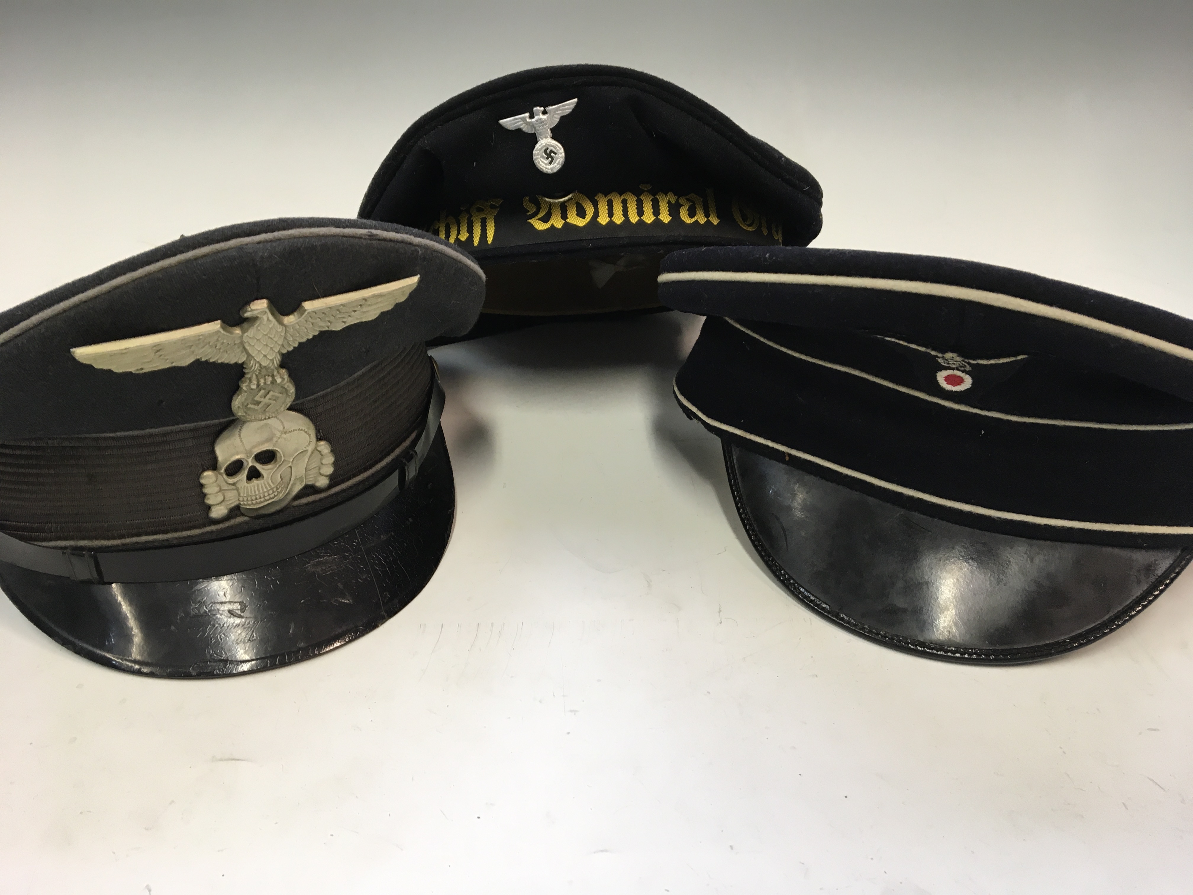 Three German Nazi style military hats.