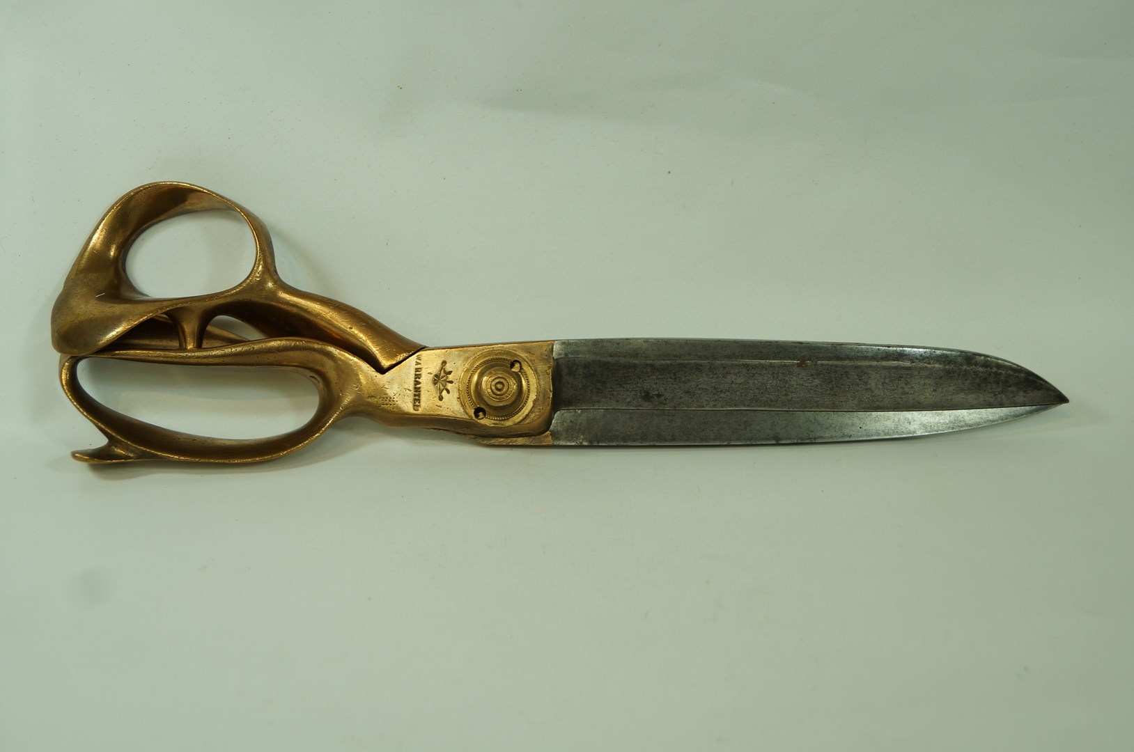 A Victorian pair of tailor's scissors with brass handles by T ...