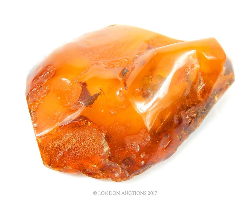 A large chunk of natural Baltic amber, containing some flakes of gold ...
