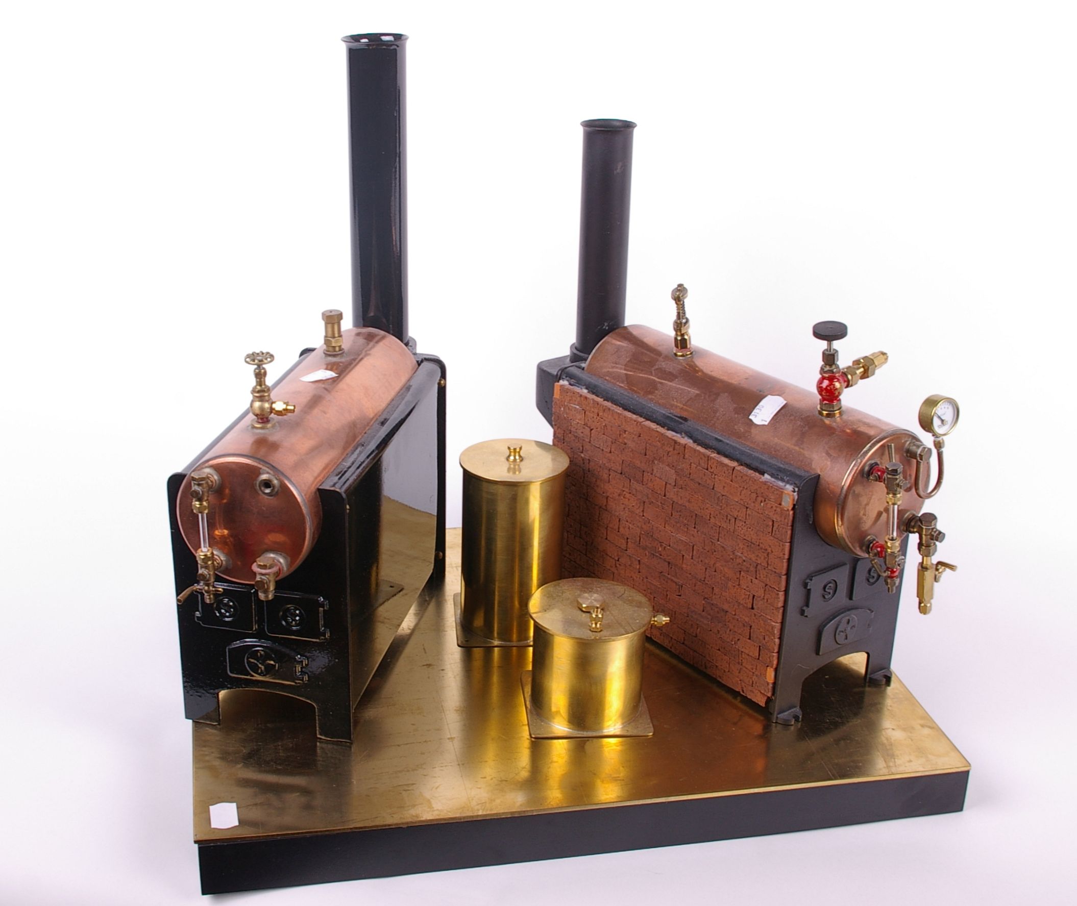 Two Stuart model horizontal copper boilers on cast iron stands together ...