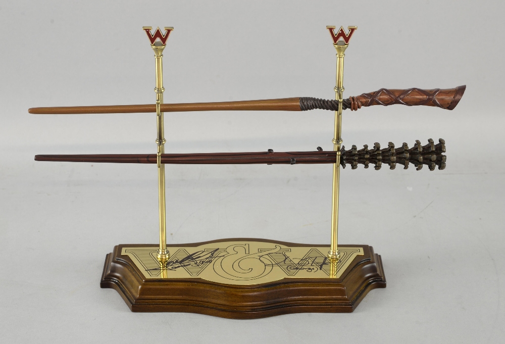 Harry Potter - A signed Official Weasley Wand display, with two replica ...