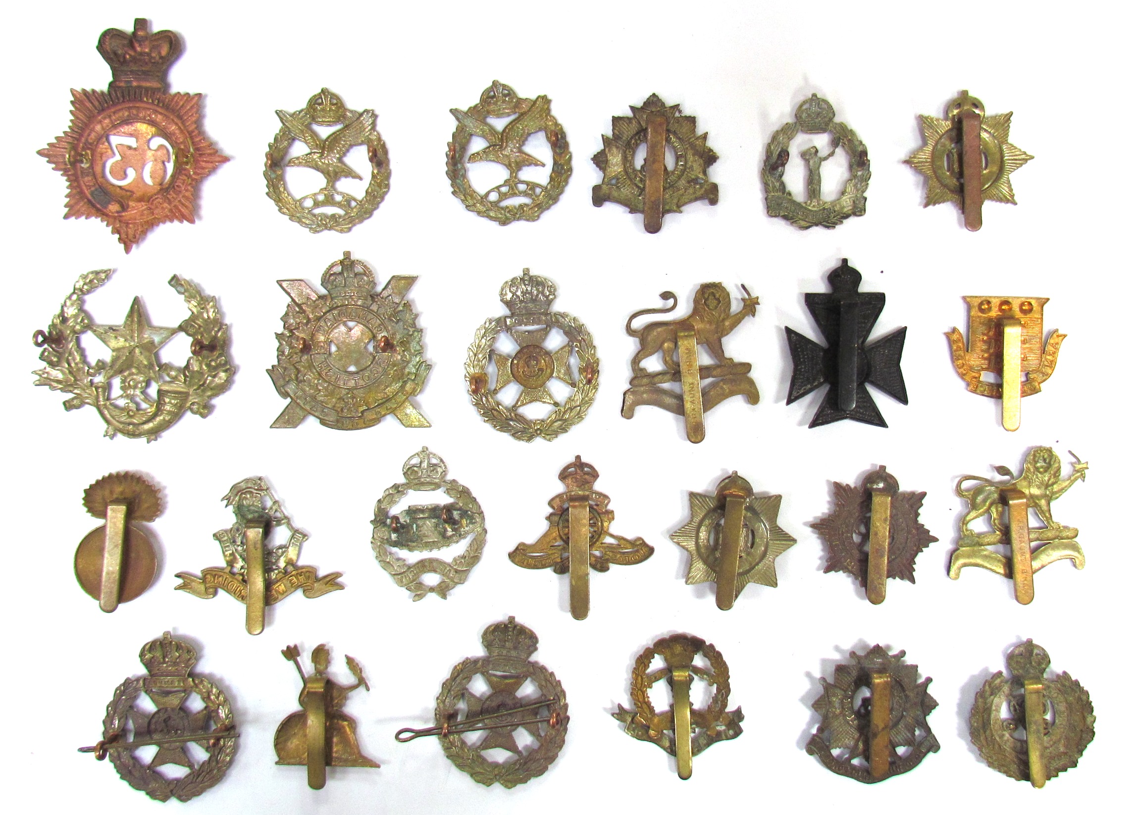 A collection of cap badges, approximately 40 regiments