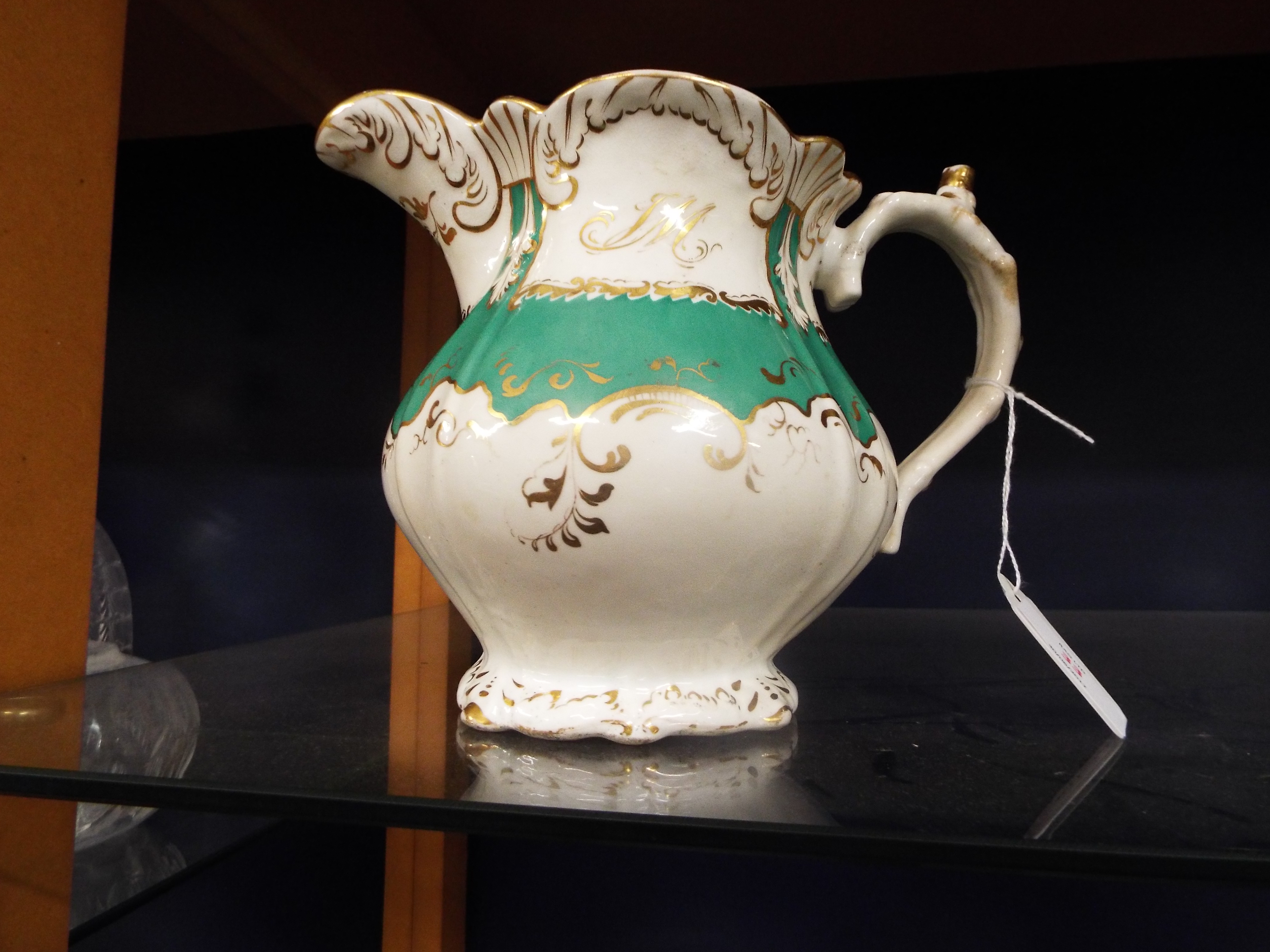 A 19thC Rockingham porcelain jug with green and gilt scrolling ...