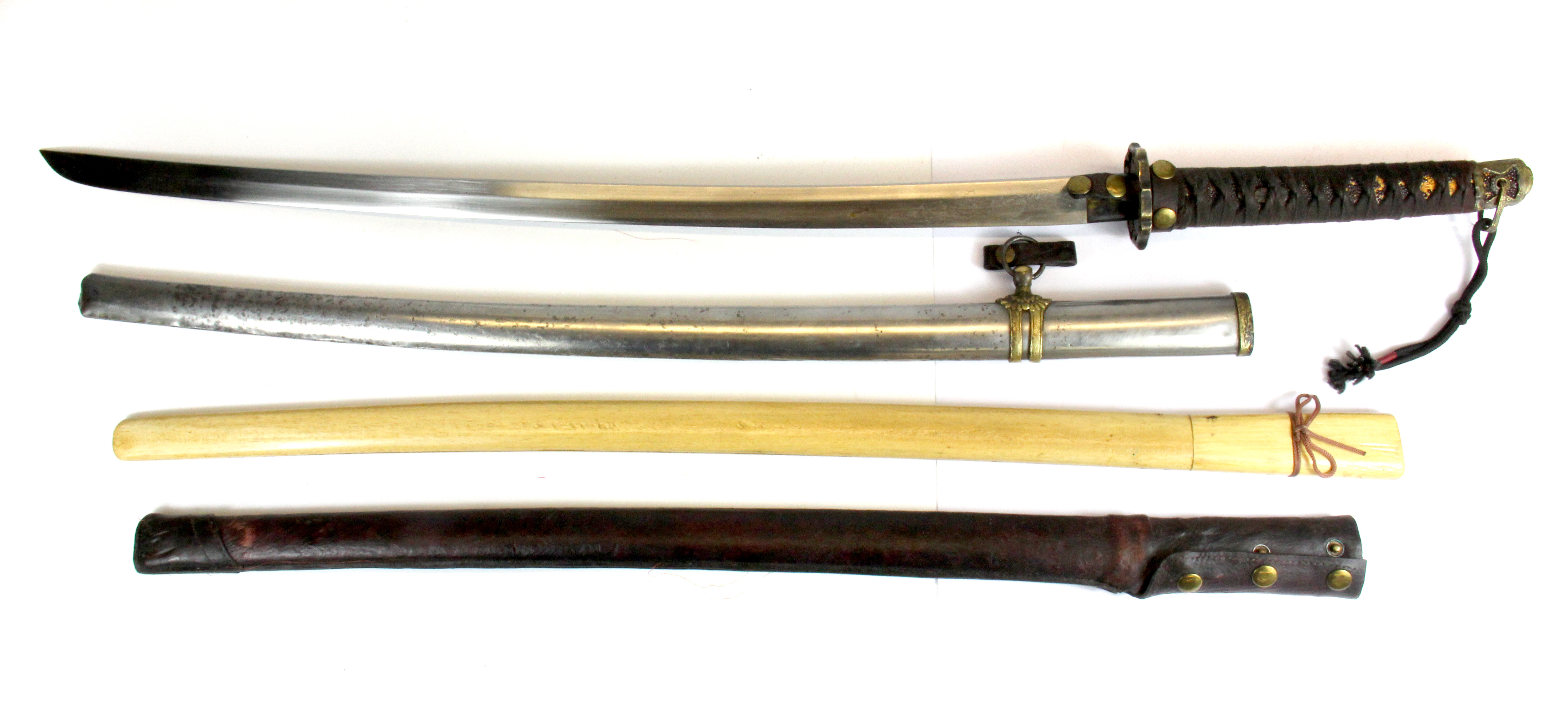A Japanese shin gunto sword with polished steel and brass mounted ...