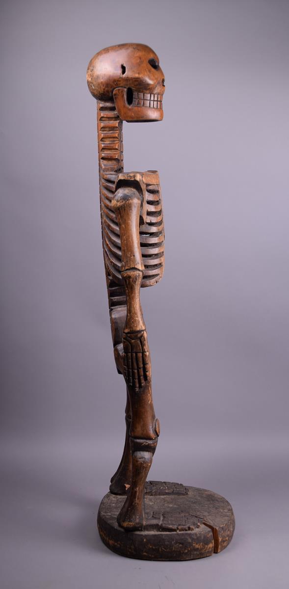 An African skeleton wood, carved in a standing position, 109cm high.