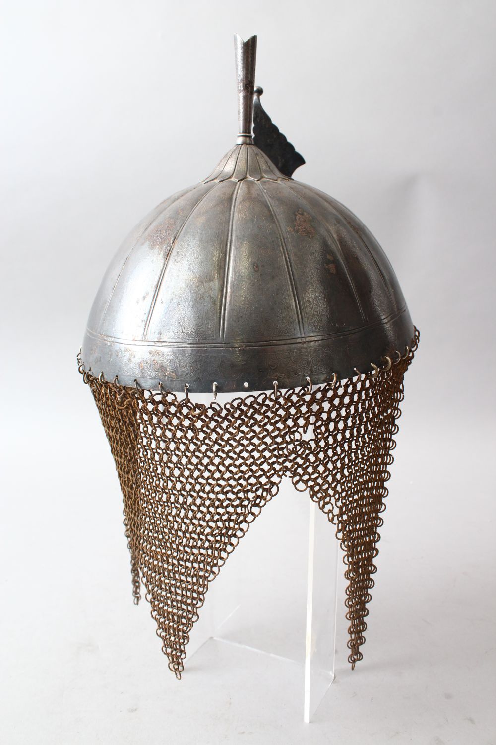 AN EARLY INDIAN STEEL HELMET, with incised decoration.