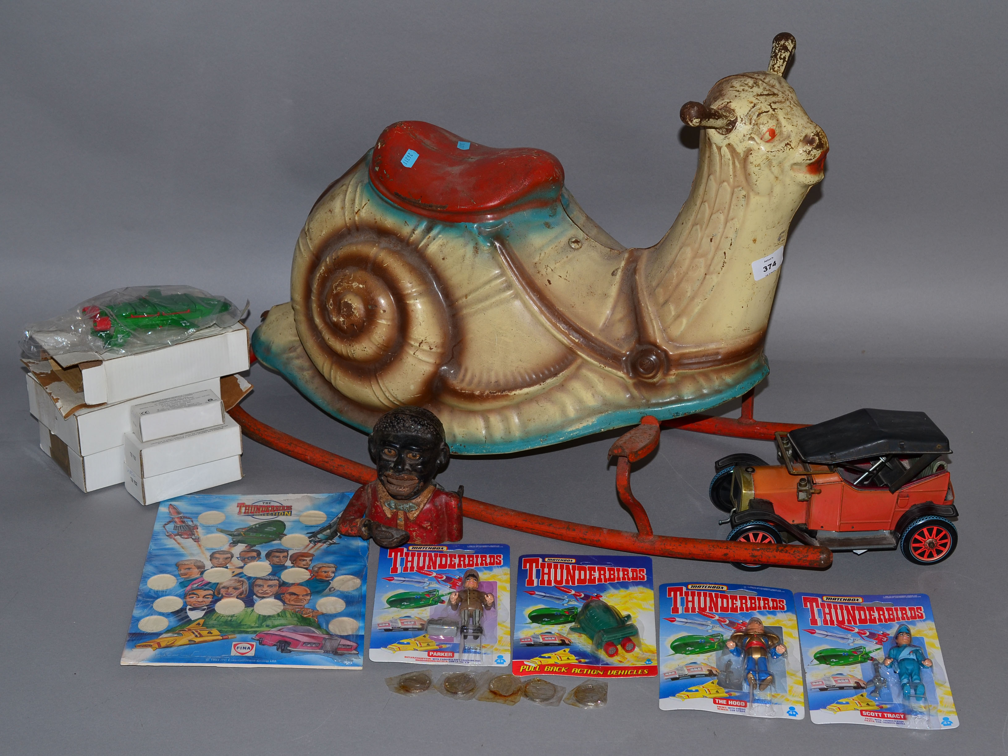 A mixed lot: Mobo Rocking Snail; Jolly cast money bank; tinplate car ...
