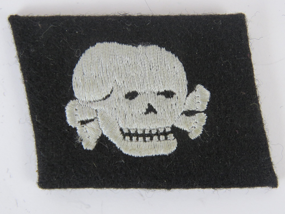 A WWII German SS Deaths Head collar patch, removed from uniform.