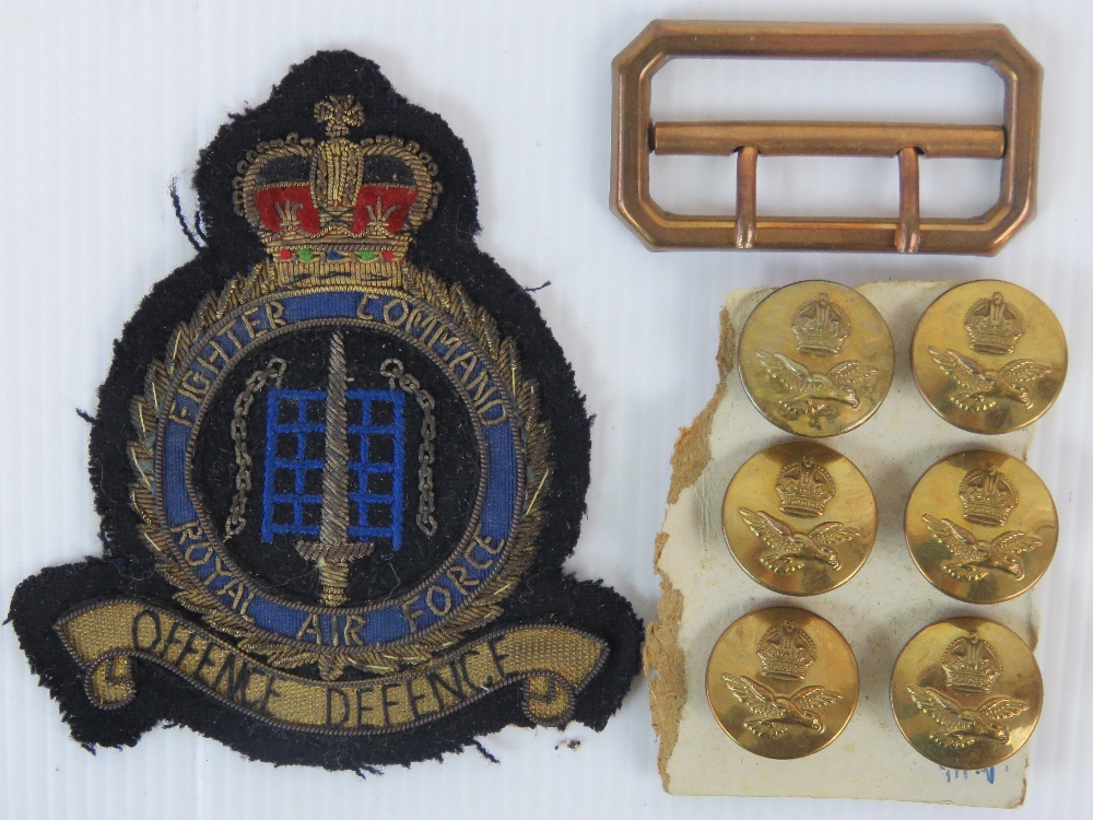 An RAF Fighter Command cloth badge, a set of six RAF buttons and a buckle.