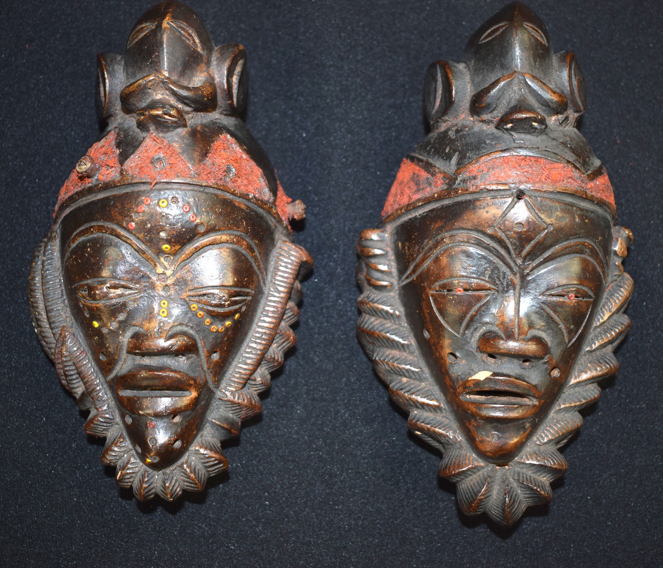 A PAIR OF EARLY 20TH CENTURY AFRICAN CLAY MASKS, with applied beadwork ...