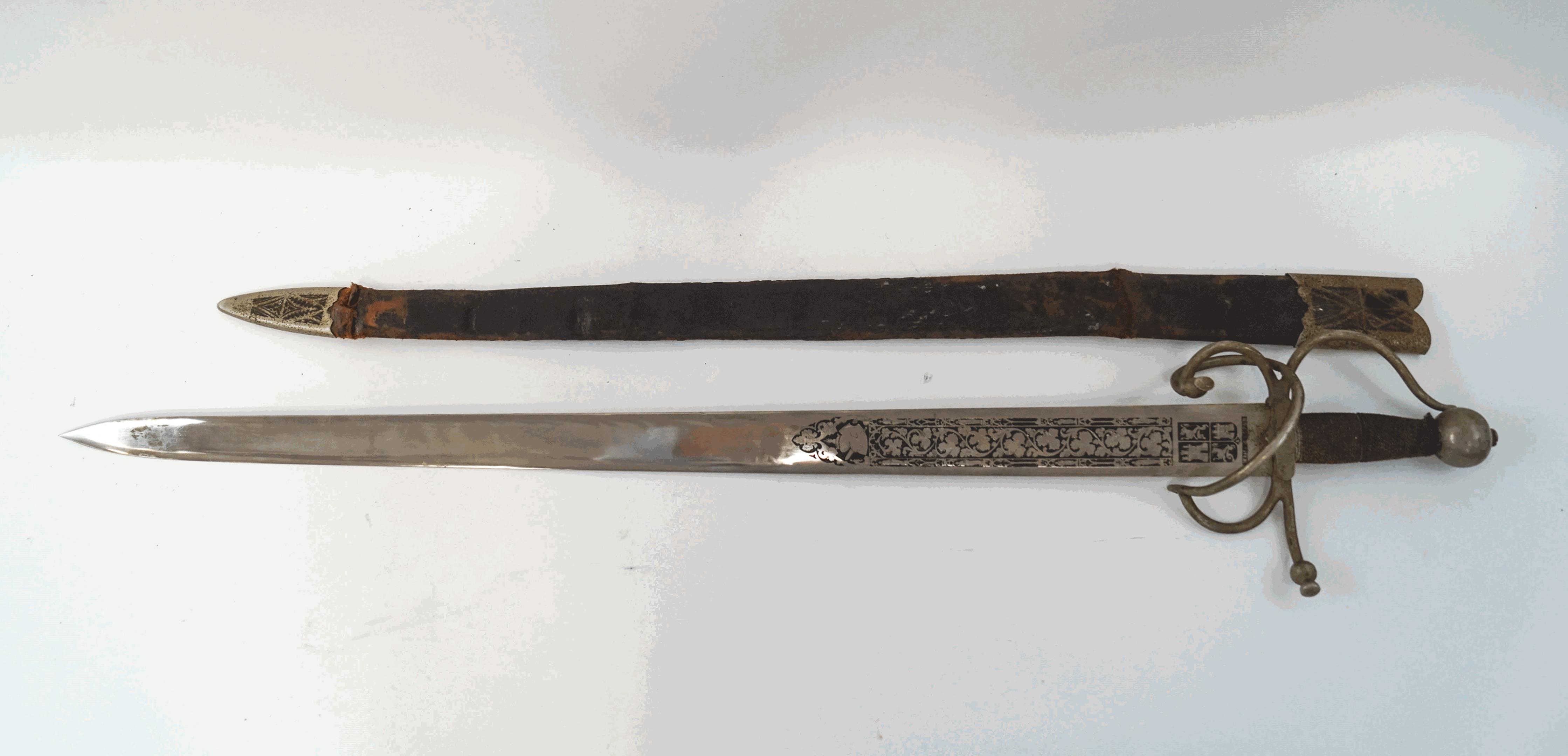 A Toledo swept hilt broad sword, the blade with heavily engraved ...