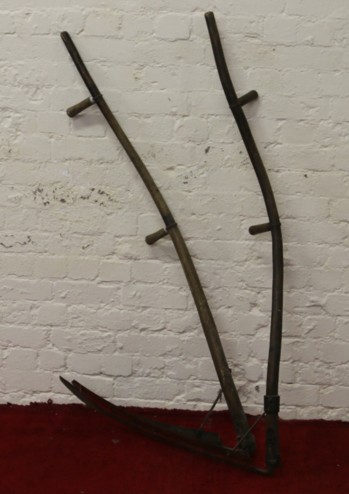 A pair of antique scythes.