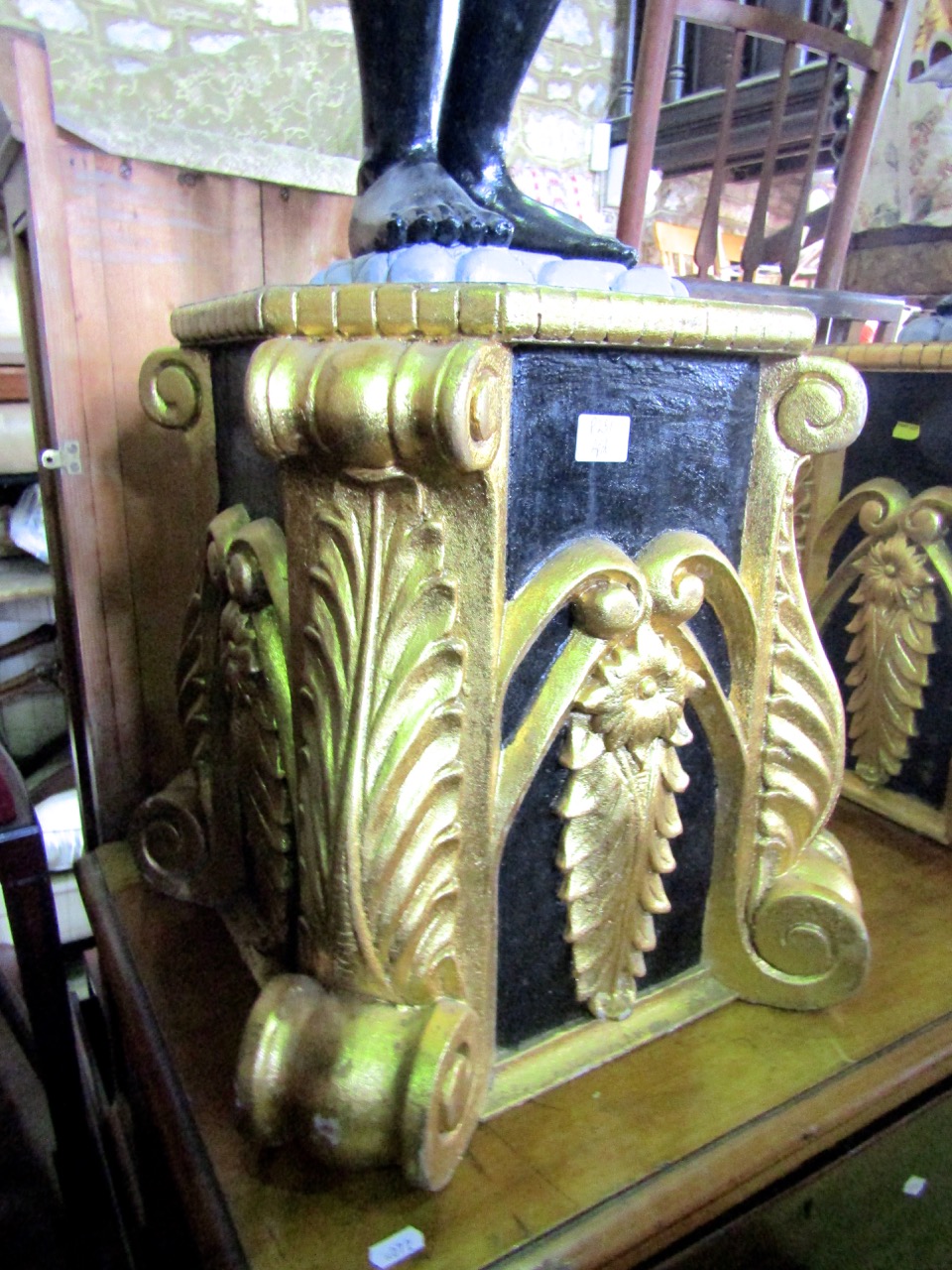 A pair of carved wooden Blackamore figures in standing pose with ...