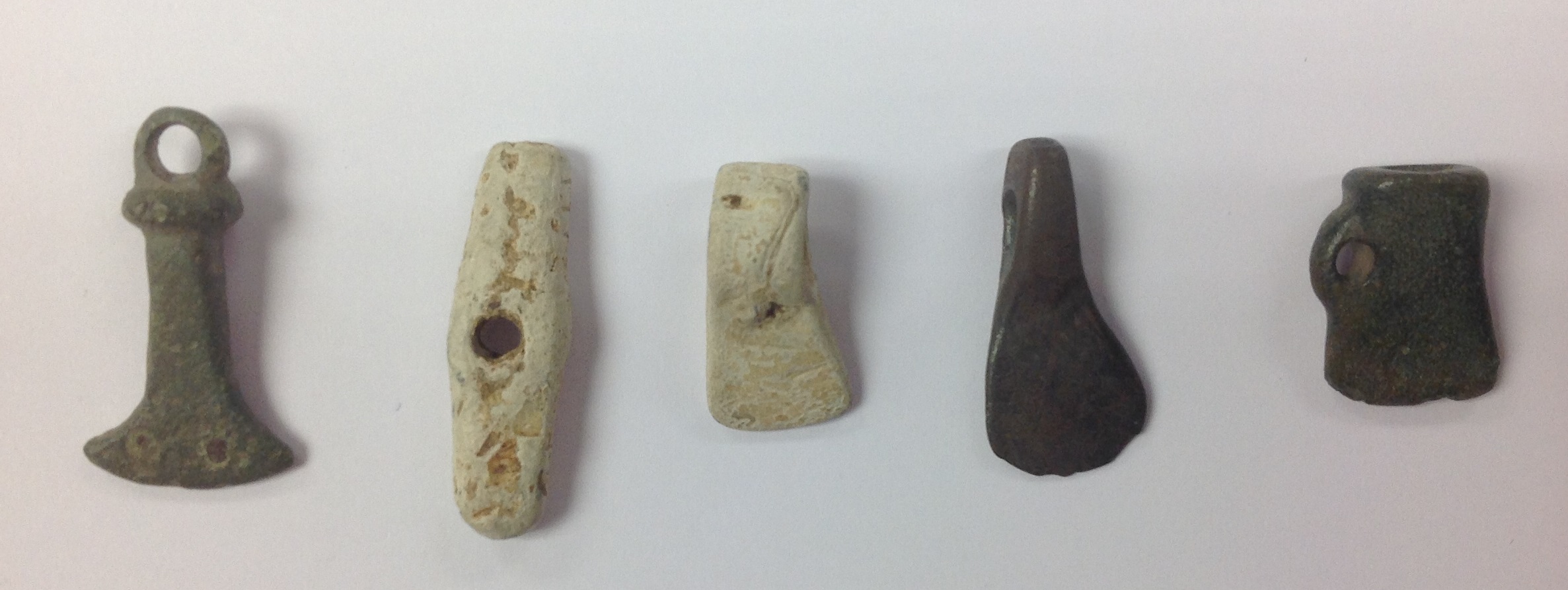 Five miniature late Bronze Age votive axes, two of lead, two bronze and ...