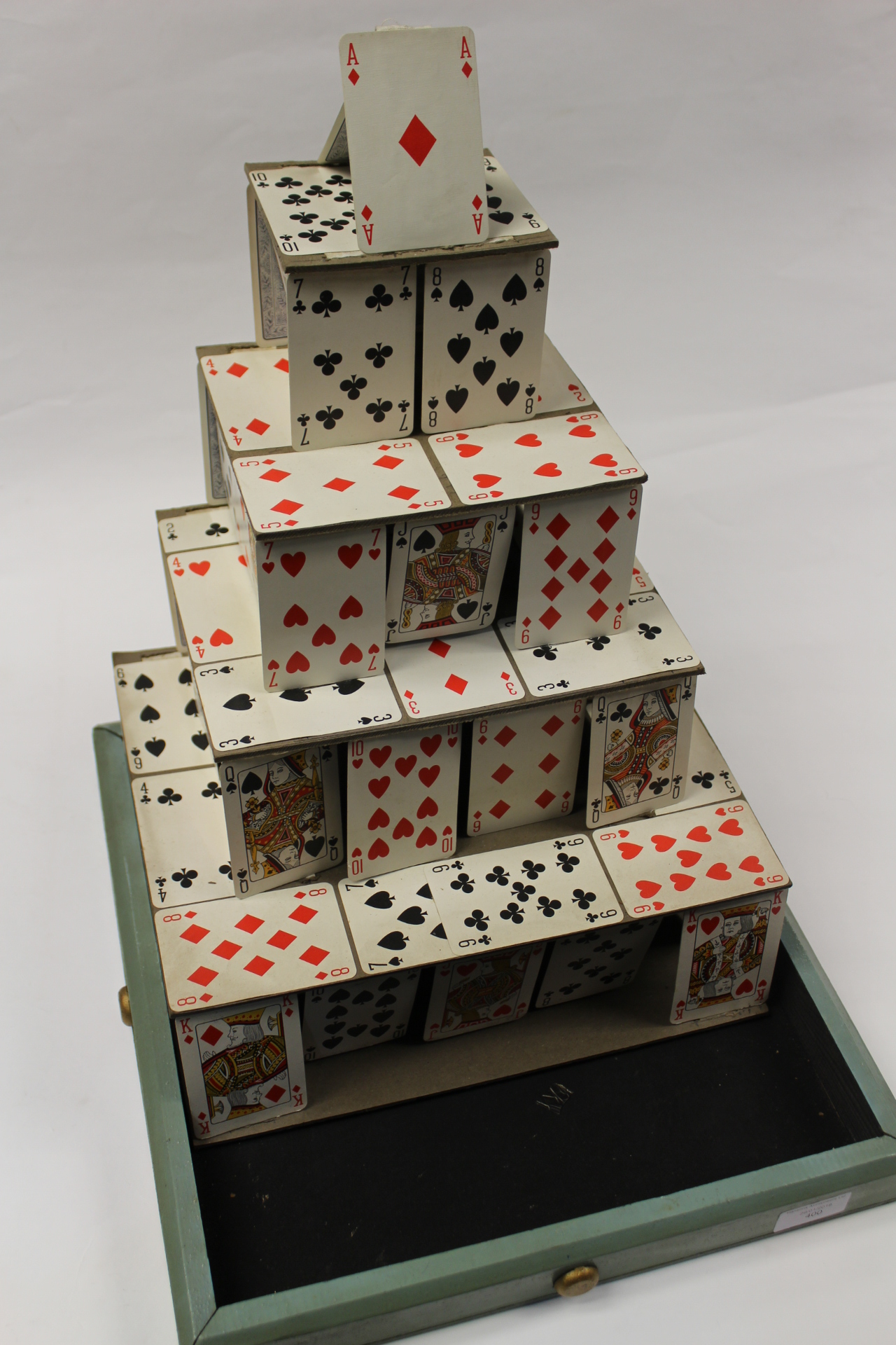 Vintage magic trick, collapsible "house of cards" on wooden stand.