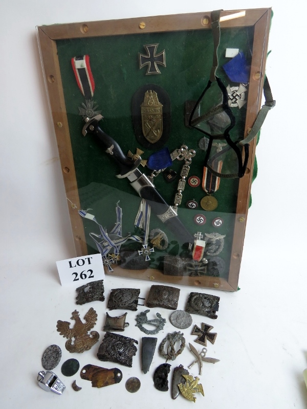 A collection of WWII Nazi memorabilia displayed in a later case, also ...