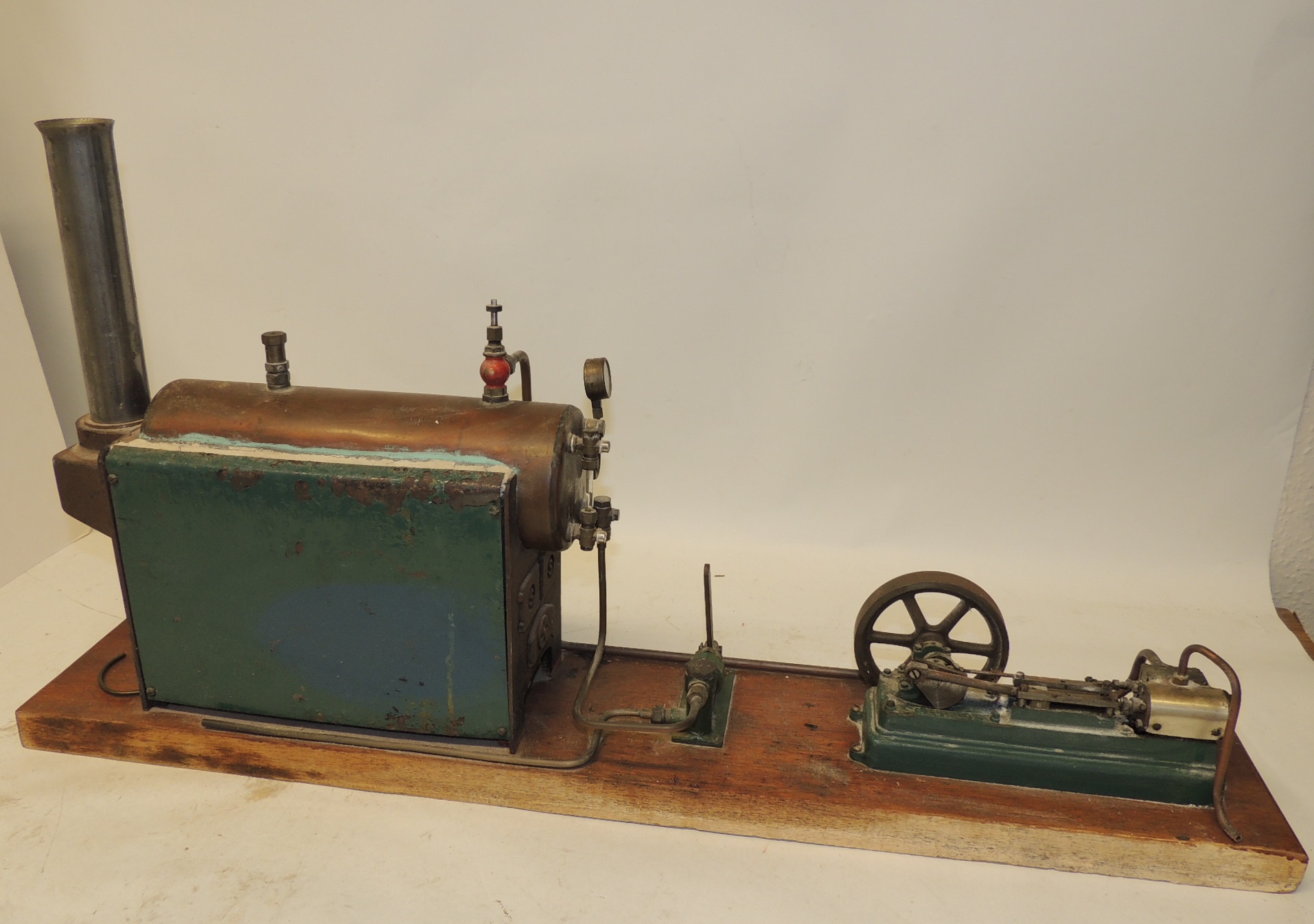 An early 20th Century stationary live steam engine having horizontal ...